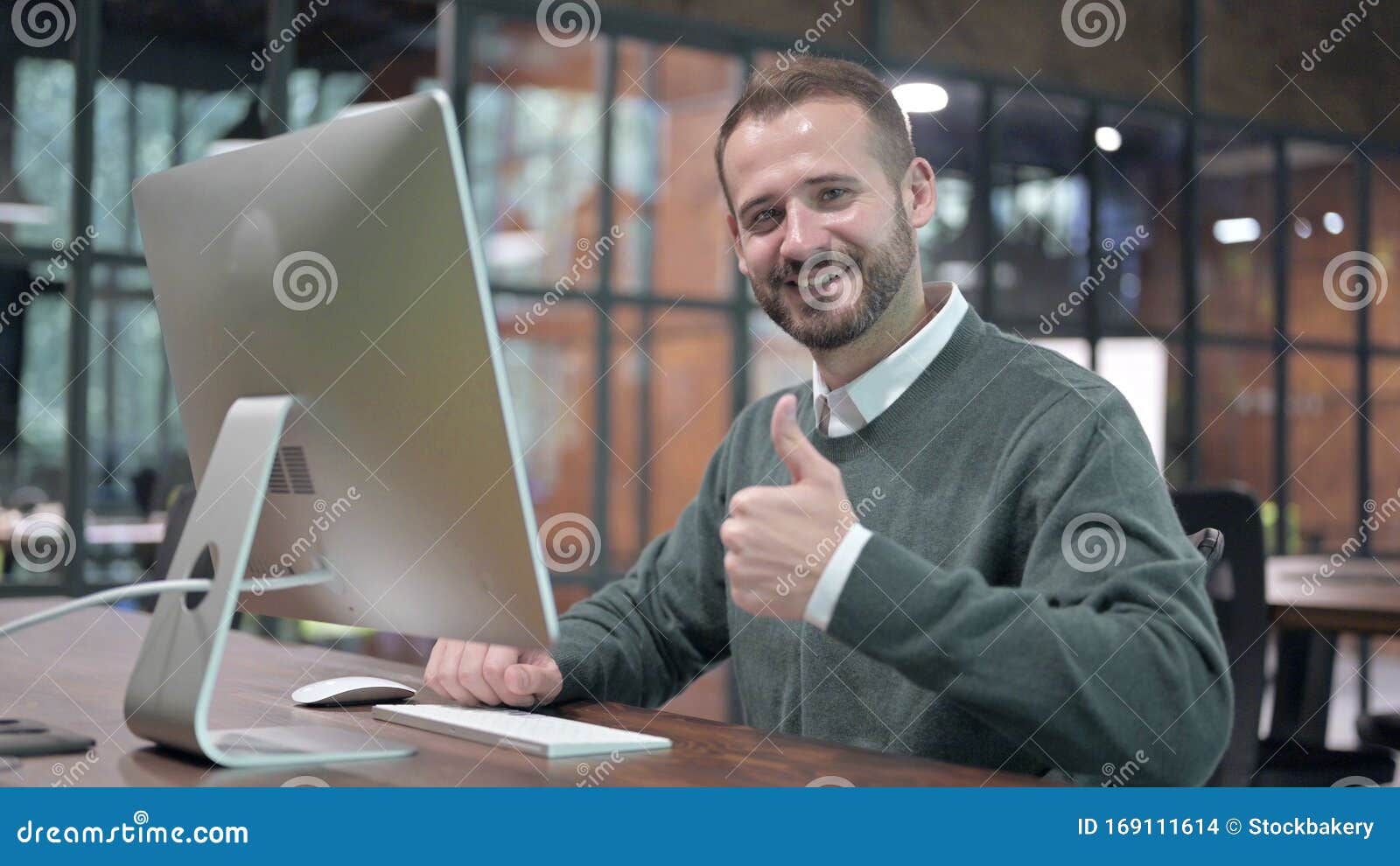 Young Man Working on Computer and Showing Thumbs Up Stock Photo - Image ...