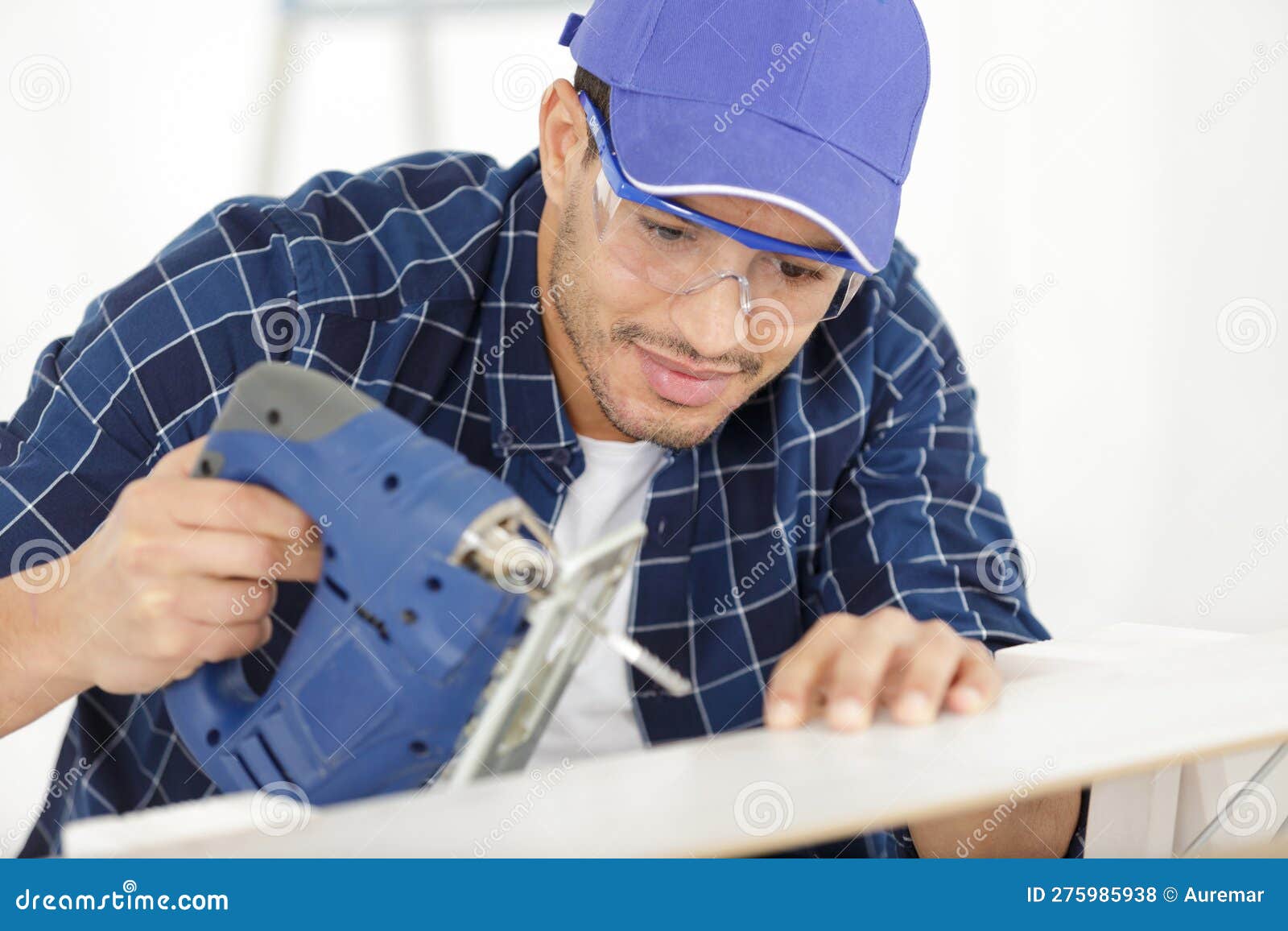 Young Man Working with Electric Jogsaw Stock Photo - Image of home ...