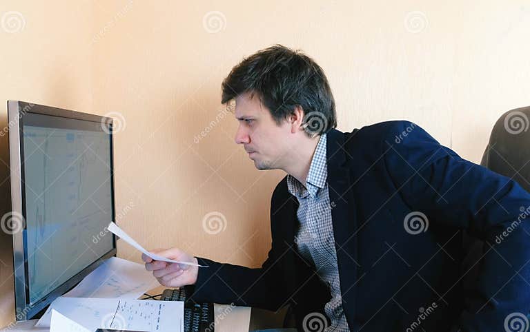 Young Man is Working Hard Behind the Computer Compare Graphics. Stock ...