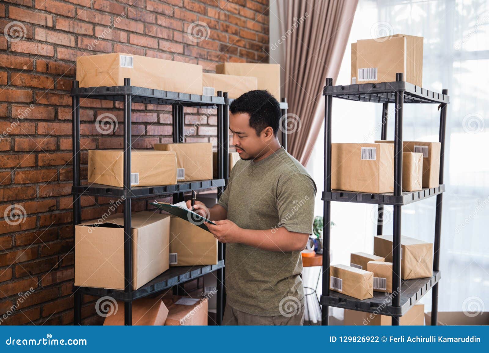 Young Man Checking Packages with the Clipboard Stock Photo - Image of ...
