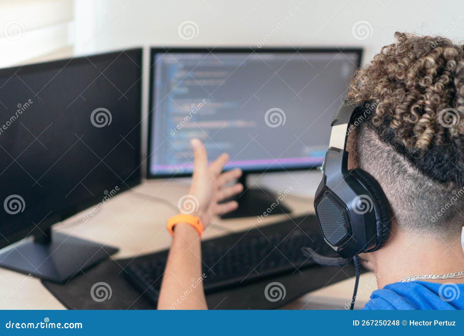 Young Man Working at Home with His Computer and Headset, Making a Video ...