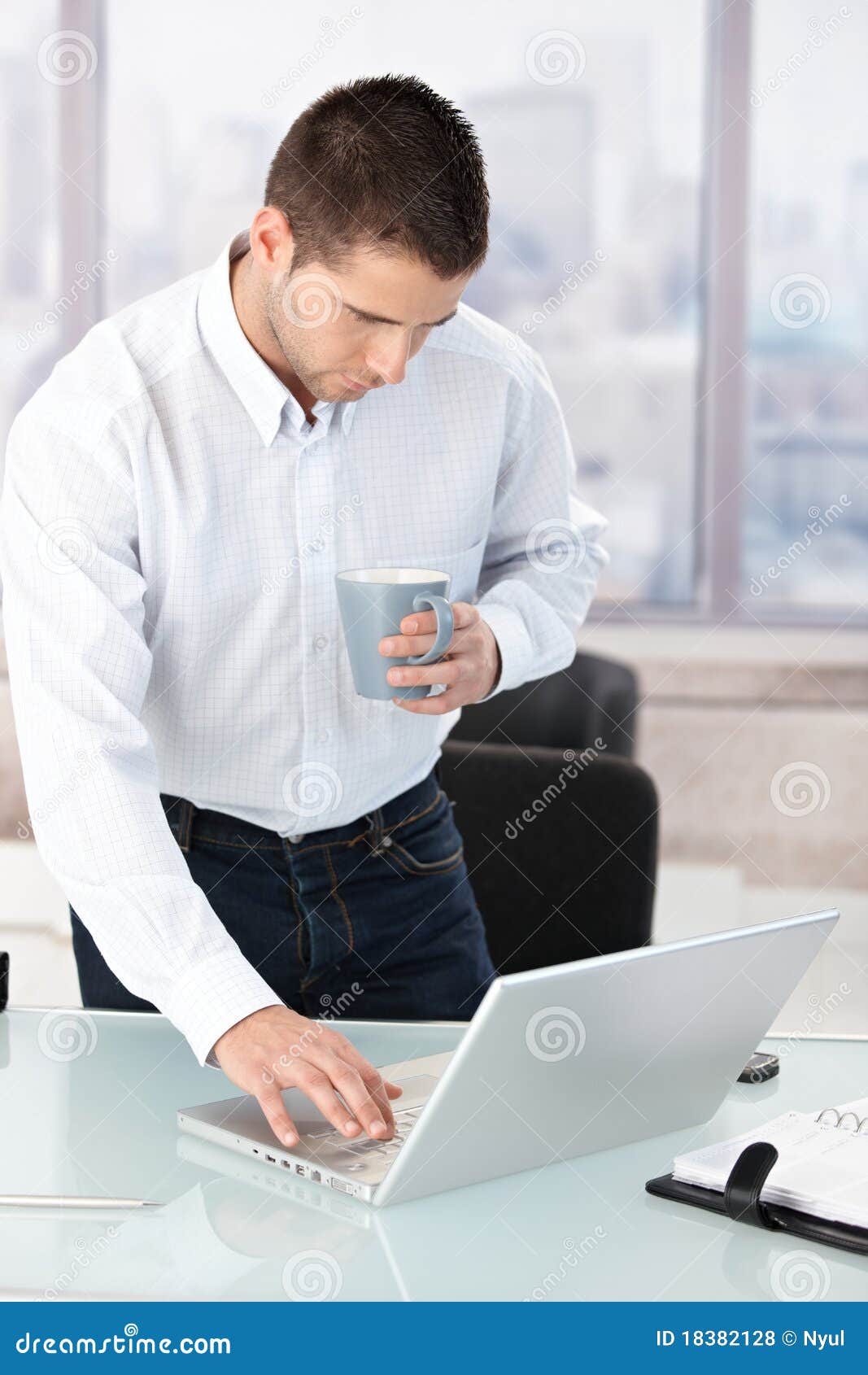 Young Man Working on Laptop in Bright Office Stock Photo - Image of ...