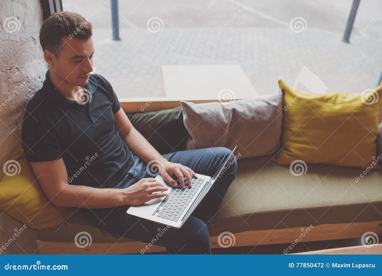 Young Man Working on Laptop while Sitting in Comfortable Couch Stock ...