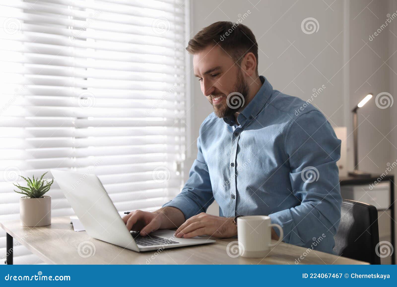 Young Man Working on Laptop at Table Stock Image - Image of notebook ...