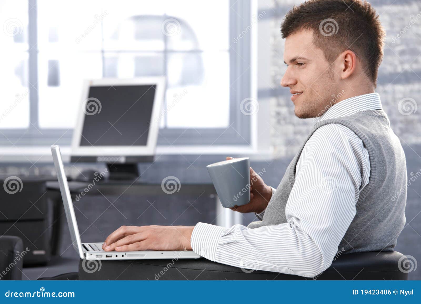 Young Man Working in Office Using Laptop Stock Photo - Image of ...