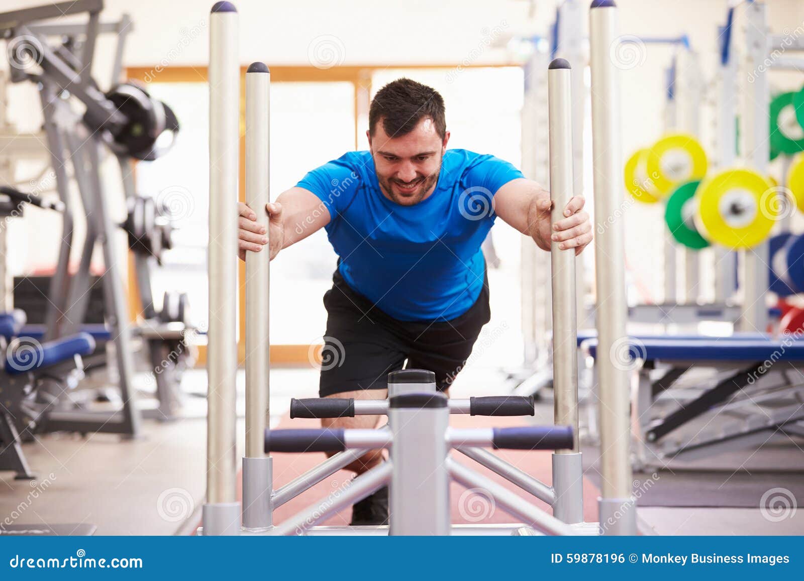 Young Man Working Out Using Equipment at a Gym Stock Photo - Image of ... Young Man Working Out Using Equipment at a Gym Stock Photo - Image of ...