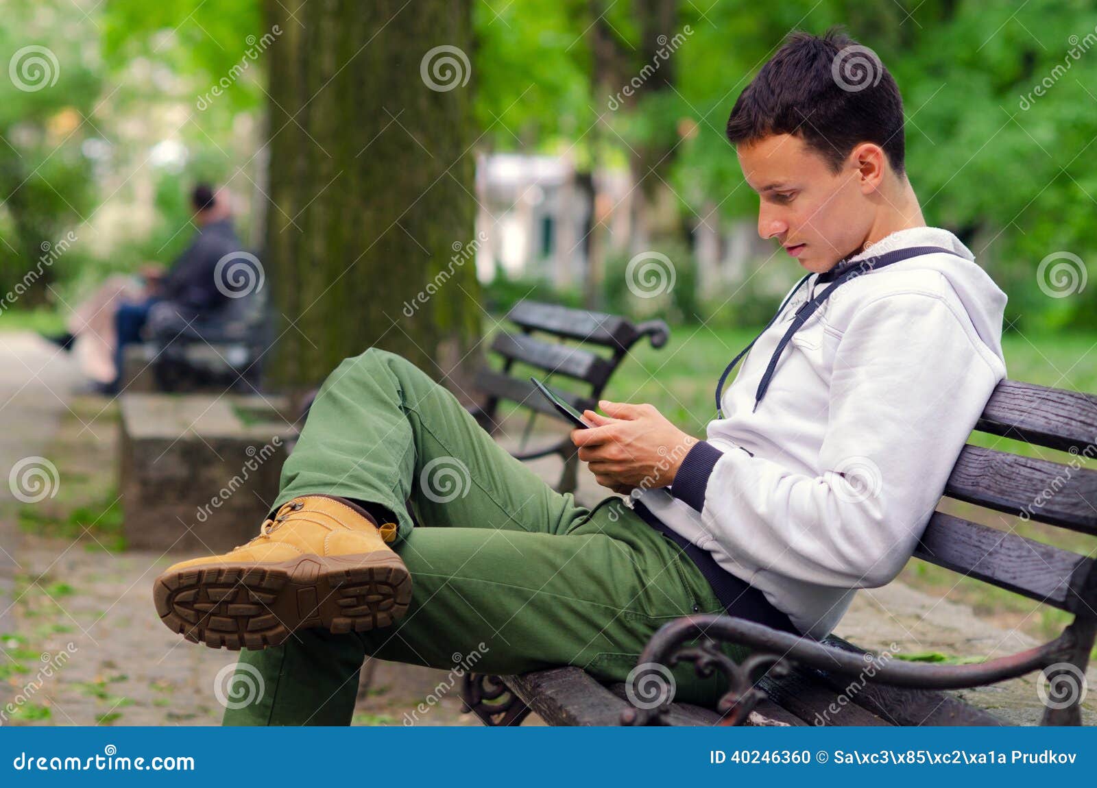 Young Man Working on Pad Device in the Park Stock Photo - Image of ...