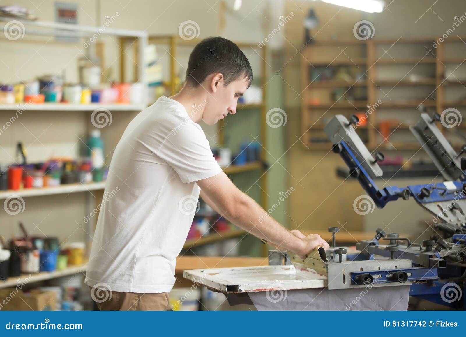Young Man Working with Squeegee on Factory Stock Photo - Image of ...