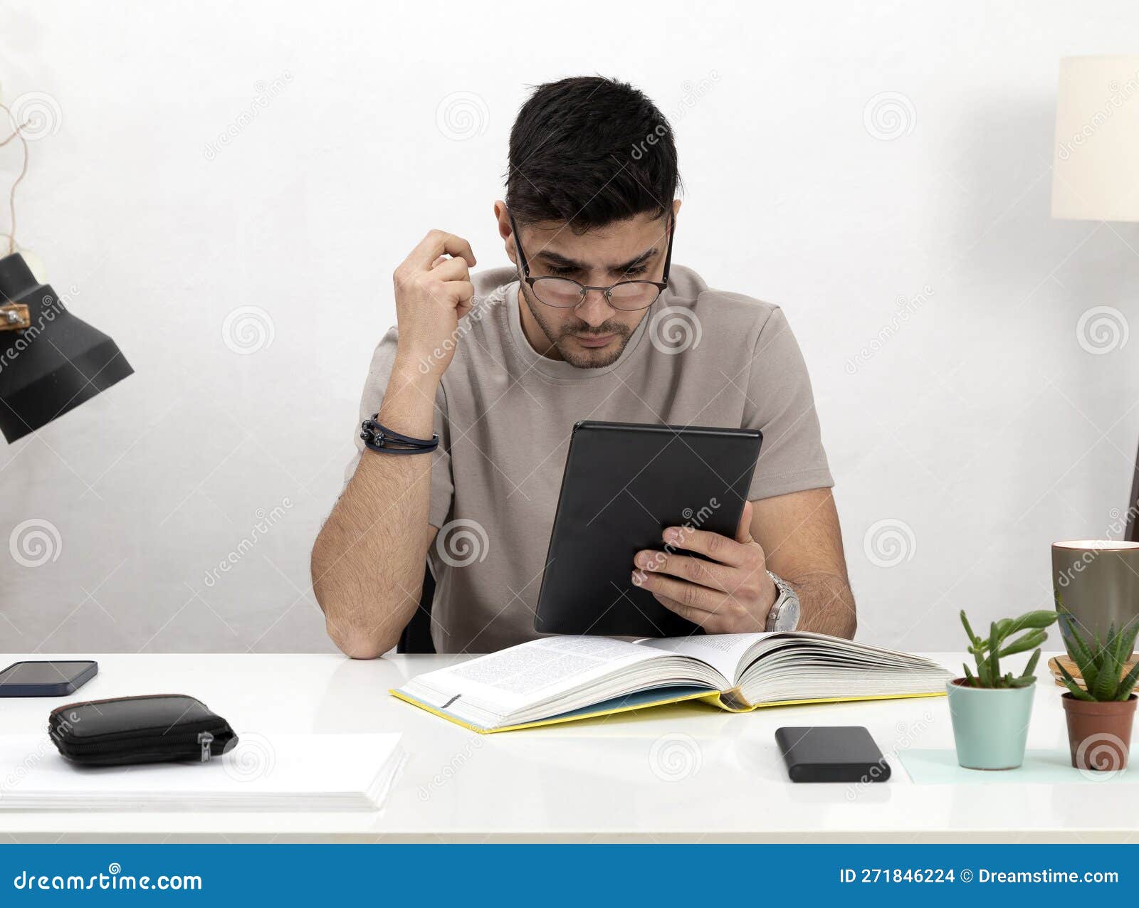 Young Man Working on Tablet in Home Office.education.business.e ...