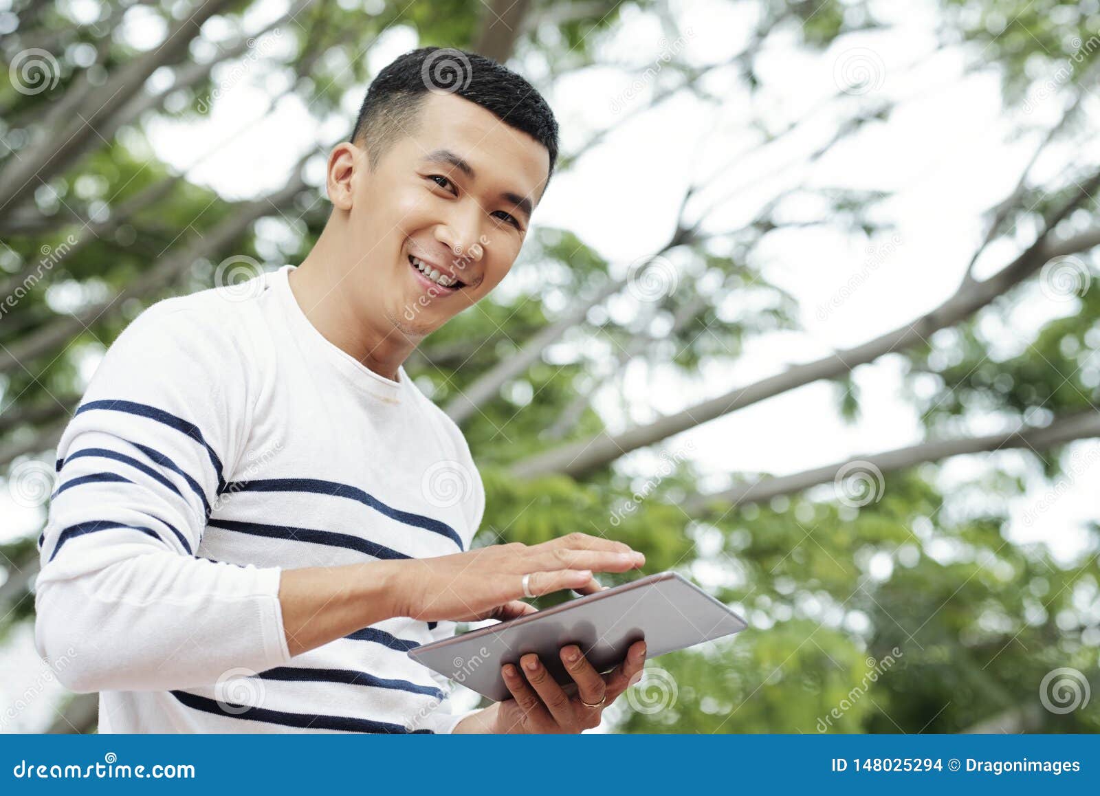 Young Man Working on Tablet Stock Photo - Image of tablet, outdoor ...