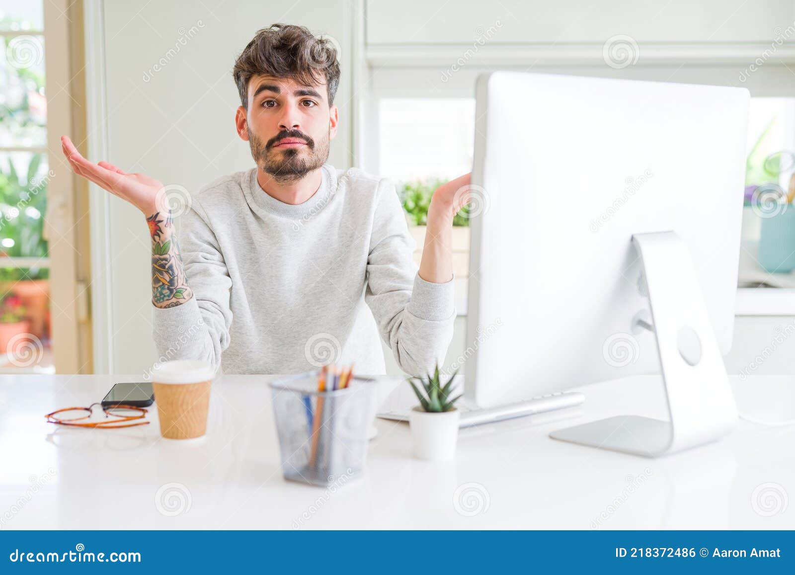 Young Man Working Using Computer Clueless and Confused Expression with ...
