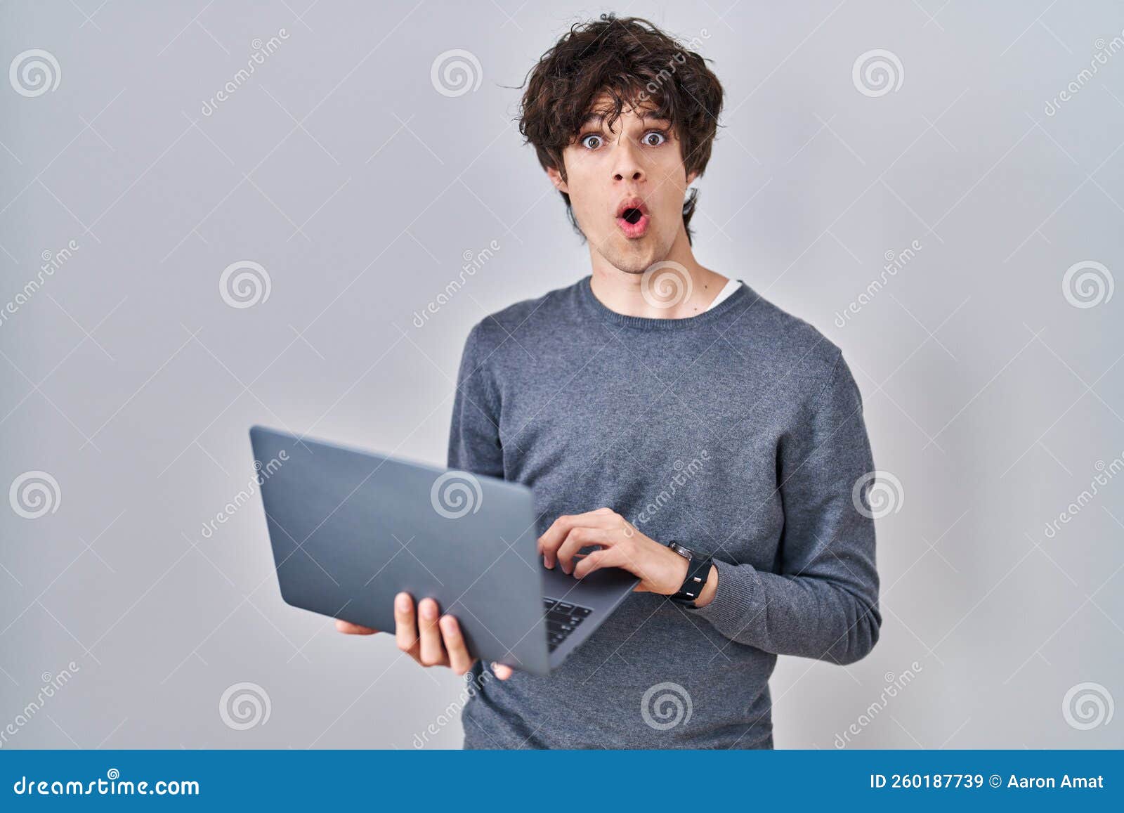 Young Man Working Using Computer Laptop Scared and Amazed with Open ...