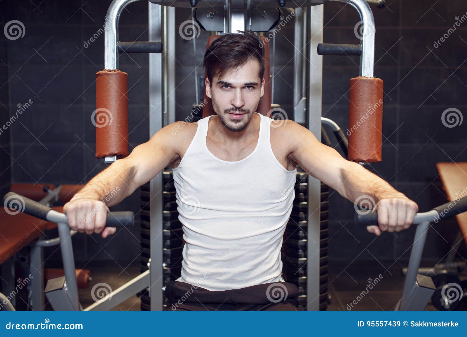 Young Man Workout in Gym by Pressing Machine Stock Image - Image of ...