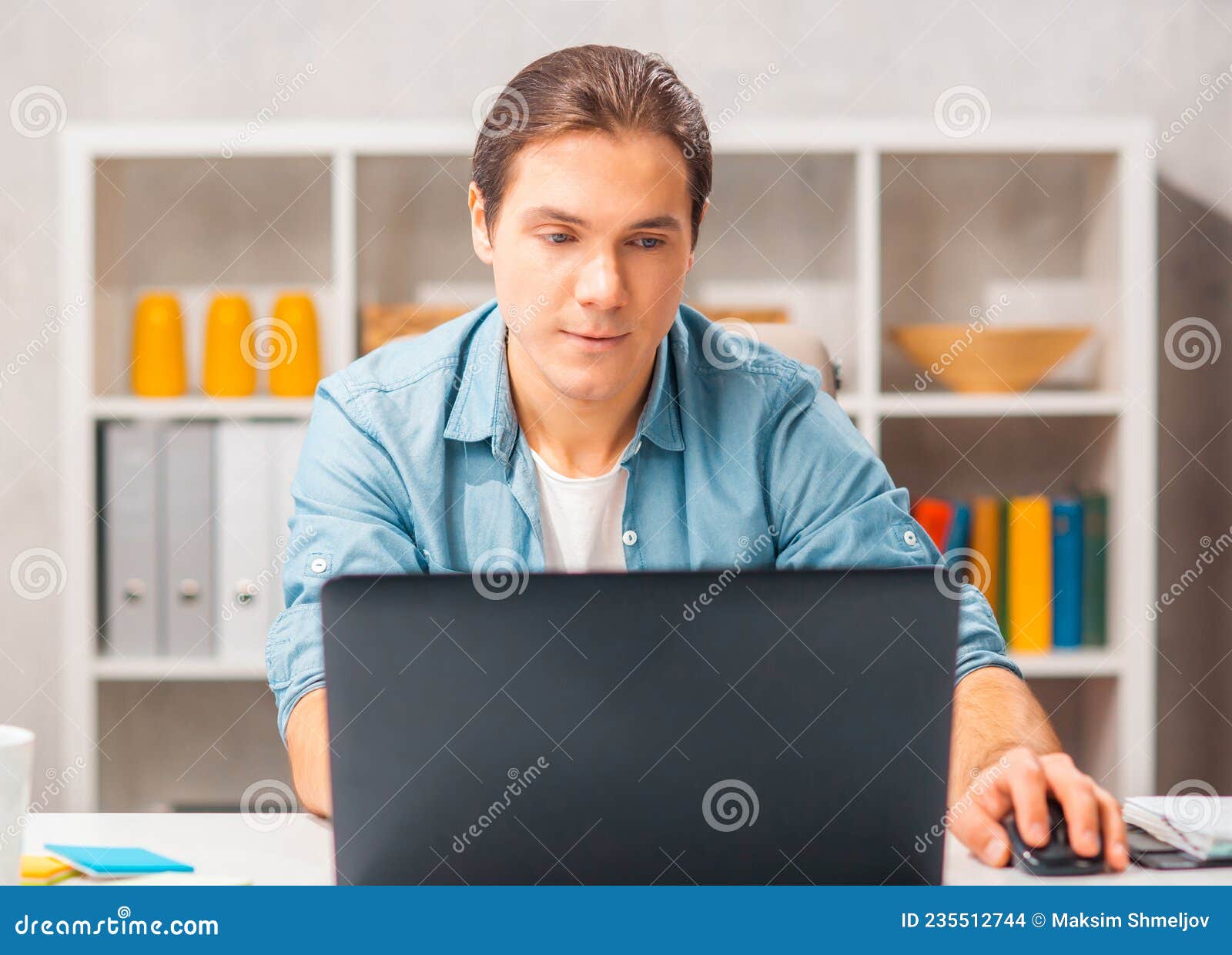Young Man Works at a Laptop Computer. Freelancer, Remote Worker or ...