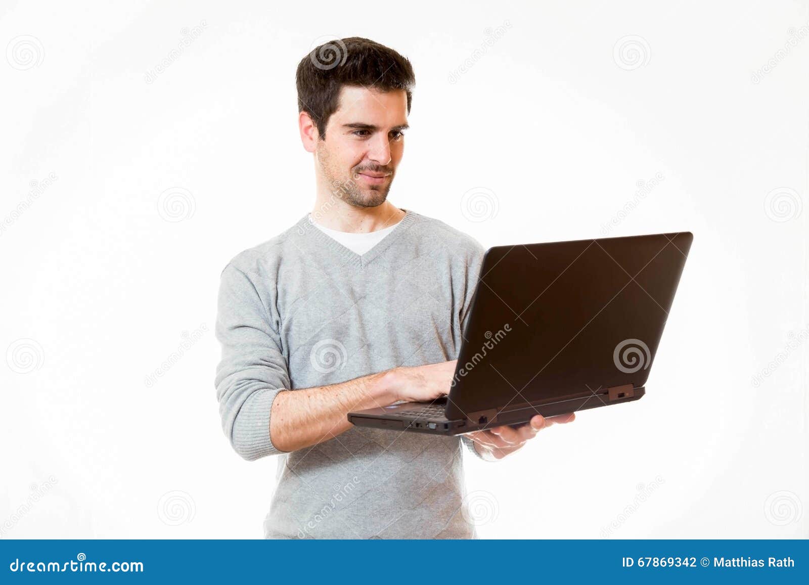 A Young Man Works on a Laptop while Standing Stock Photo - Image of ...