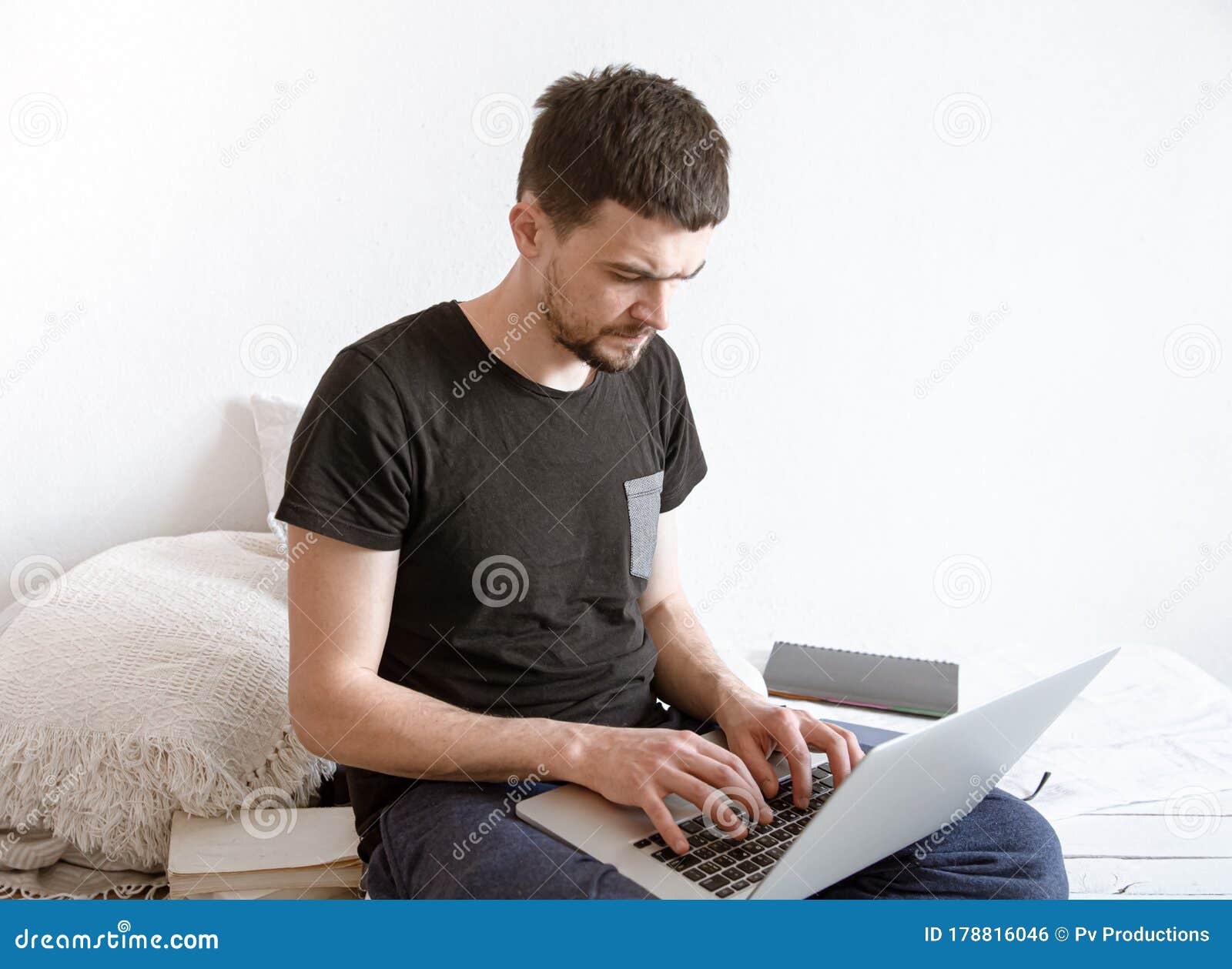 A Young Man Works Remotely at a Computer at Home Stock Photo - Image of ...
