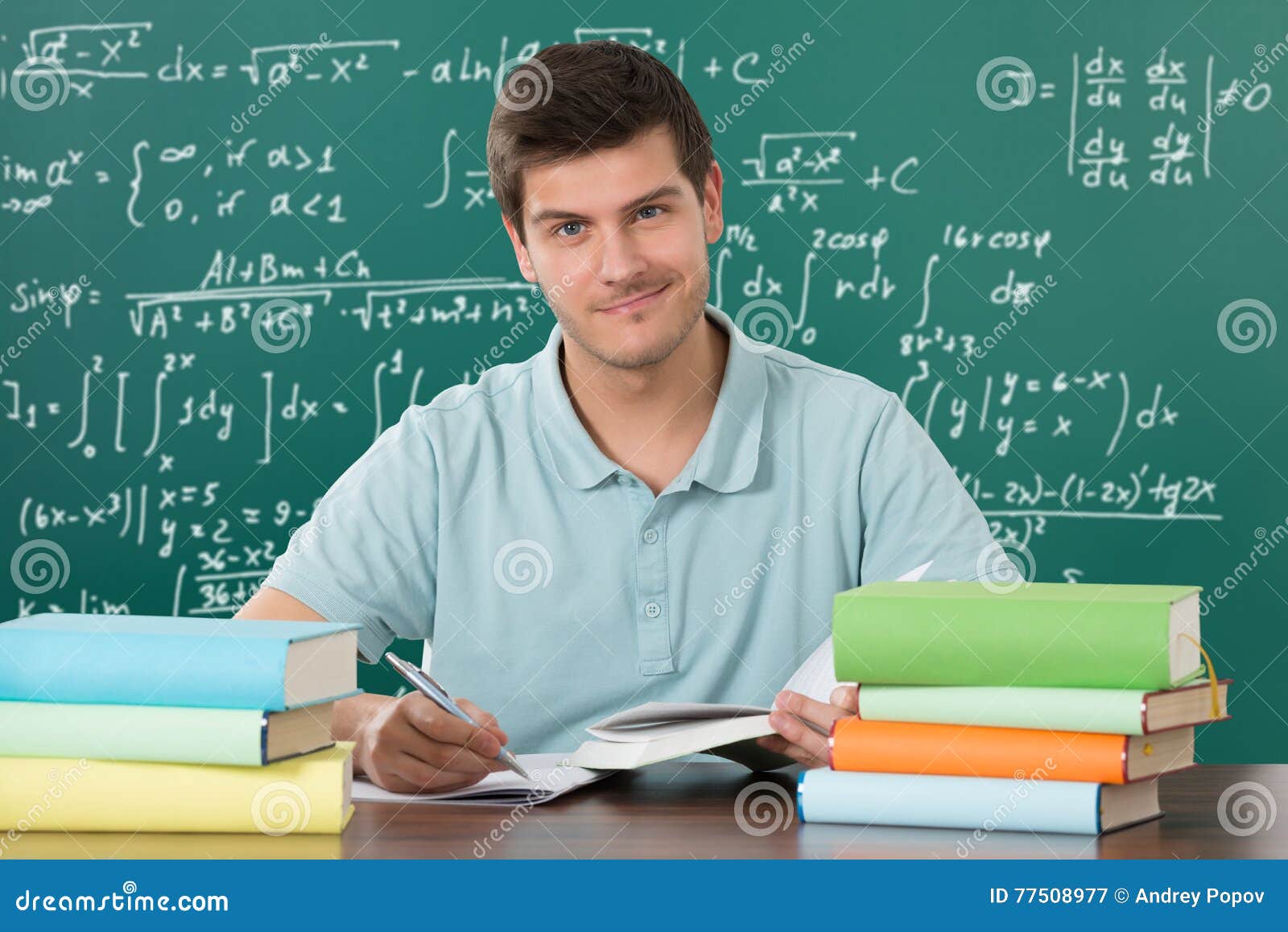 Young Man Writing in Book stock image. Image of research - 77508977