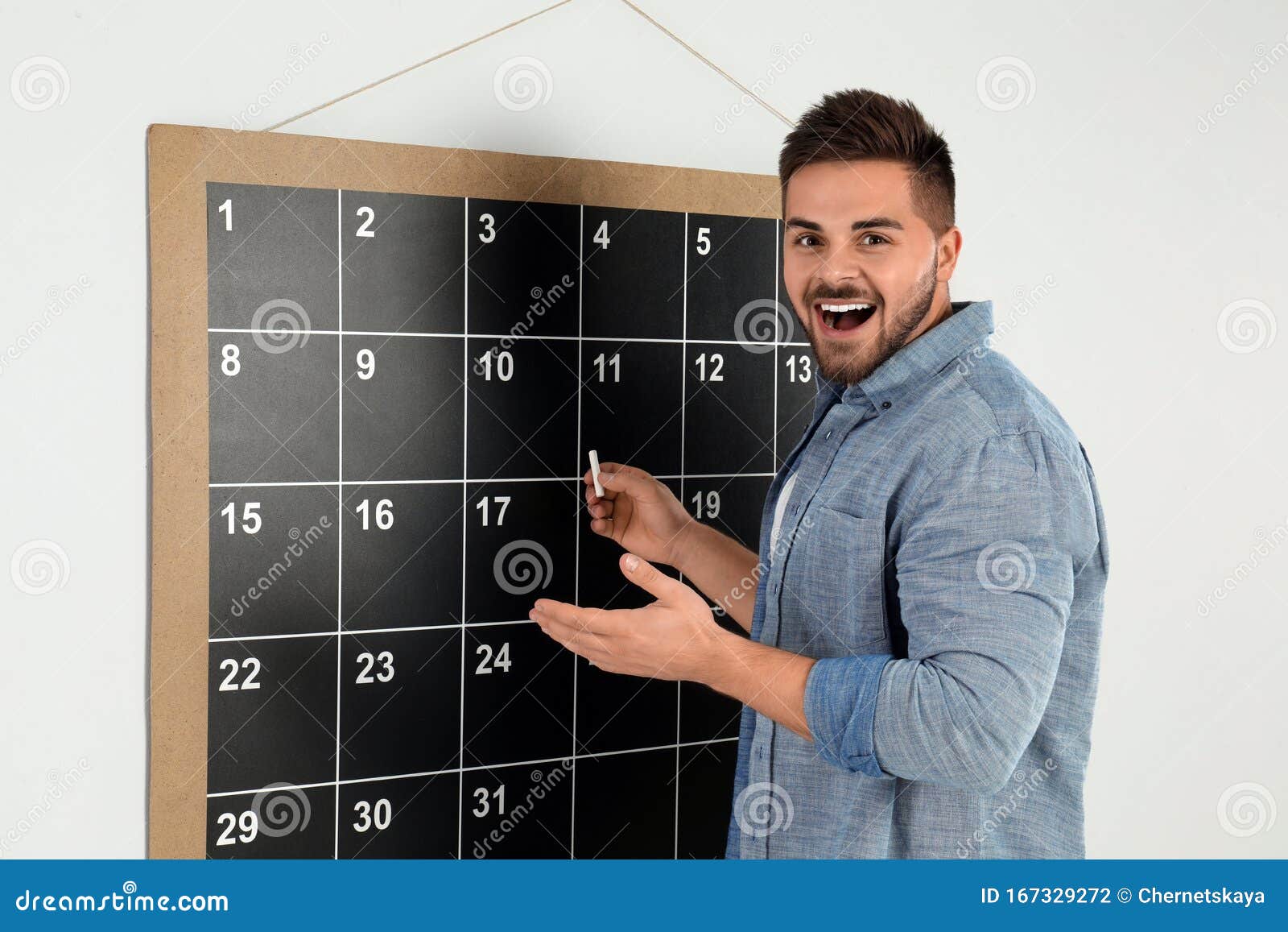Young Man Writing with Chalk on Calendar Stock Photo - Image of adult ...