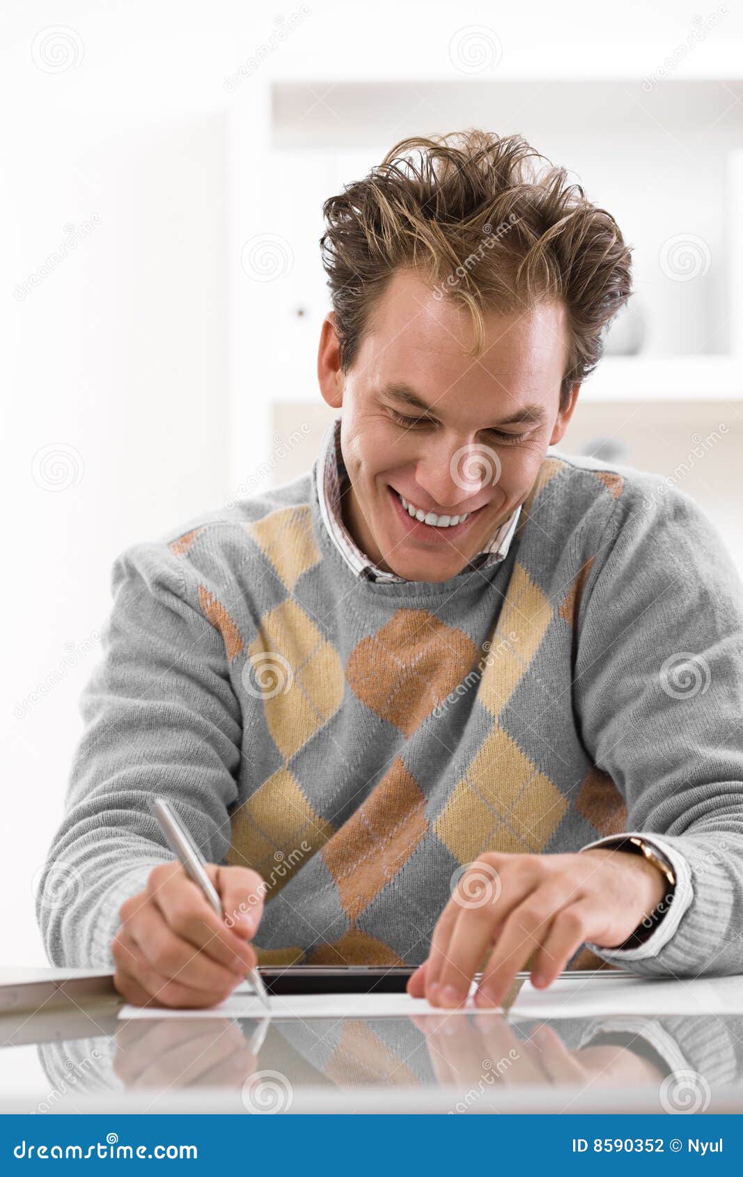 Young man writing at desk stock photo. Image of face, desk - 8590352