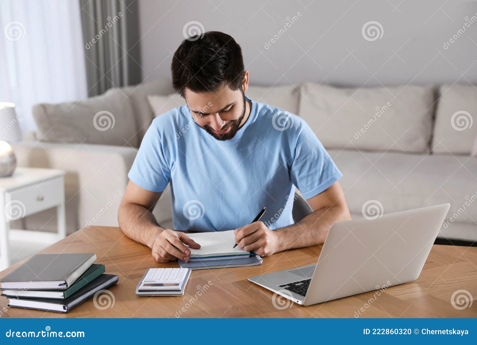 Young Man Writing Down Notes during Webinar at Table Stock Photo ...