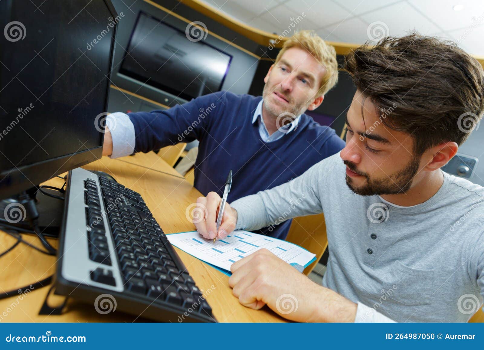 Young Man Writing on Note in Front Computer Screen Stock Photo - Image ...