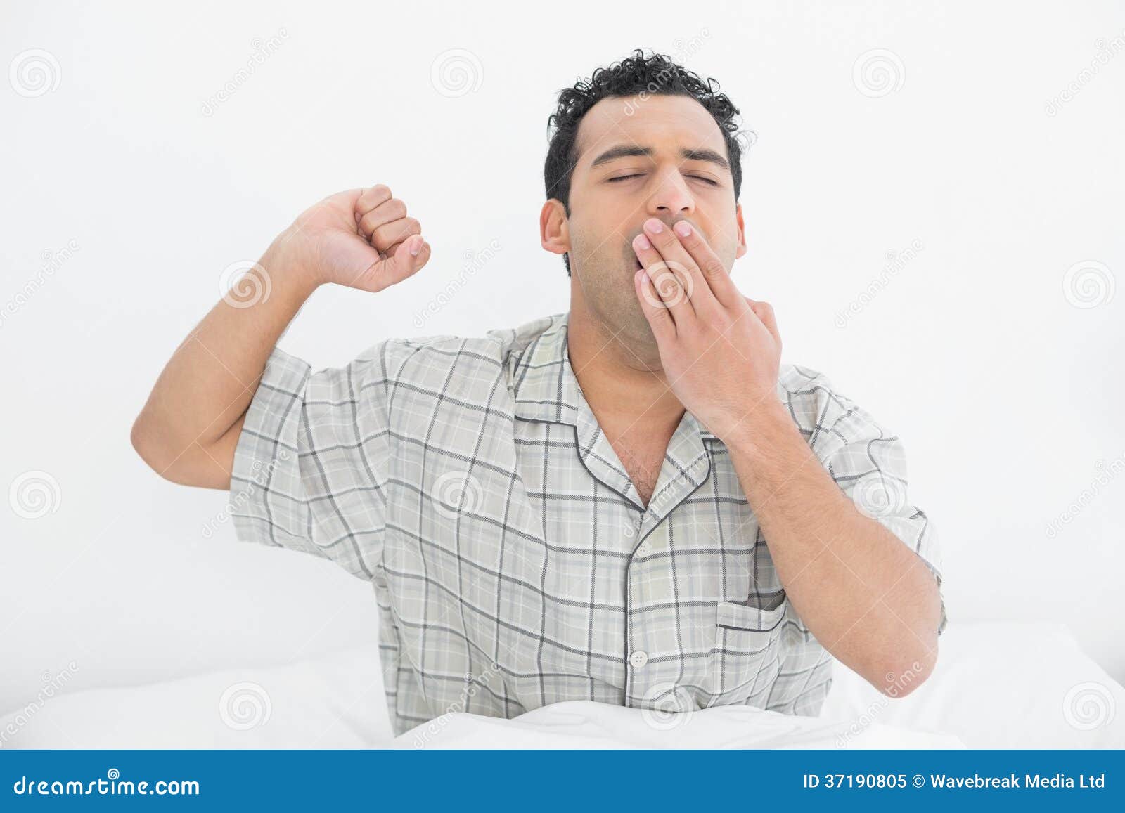 Young man yawning in bed stock image. Image of caucasian - 37190805
