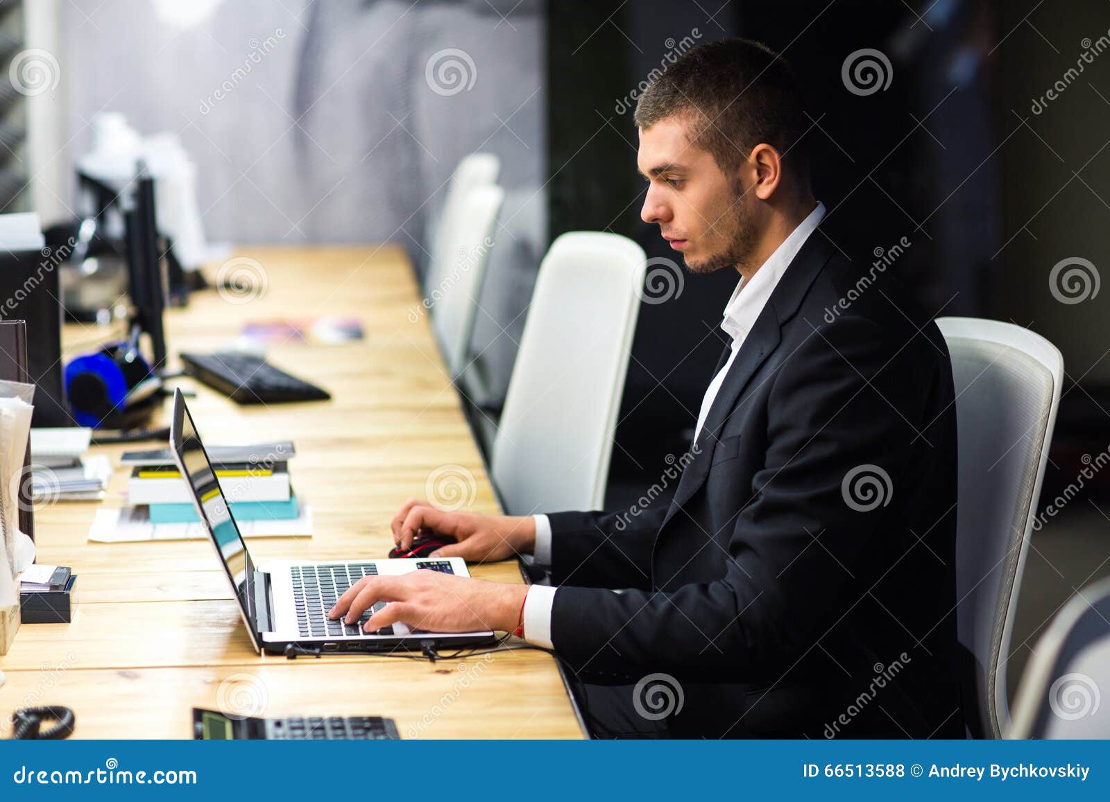 Young Manager at the Workplace. Young Man Working on Computer in Office ...