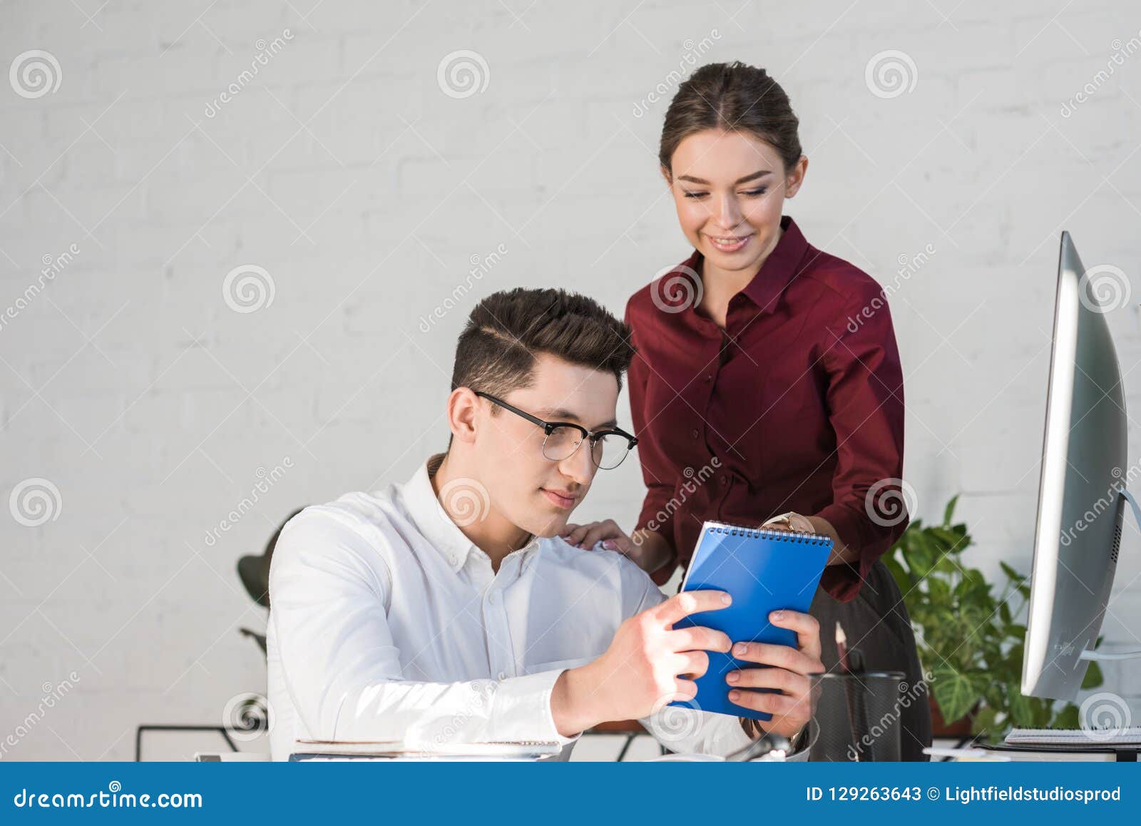 Young Managers Reading Notes Together at Workplace Stock Image - Image ...
