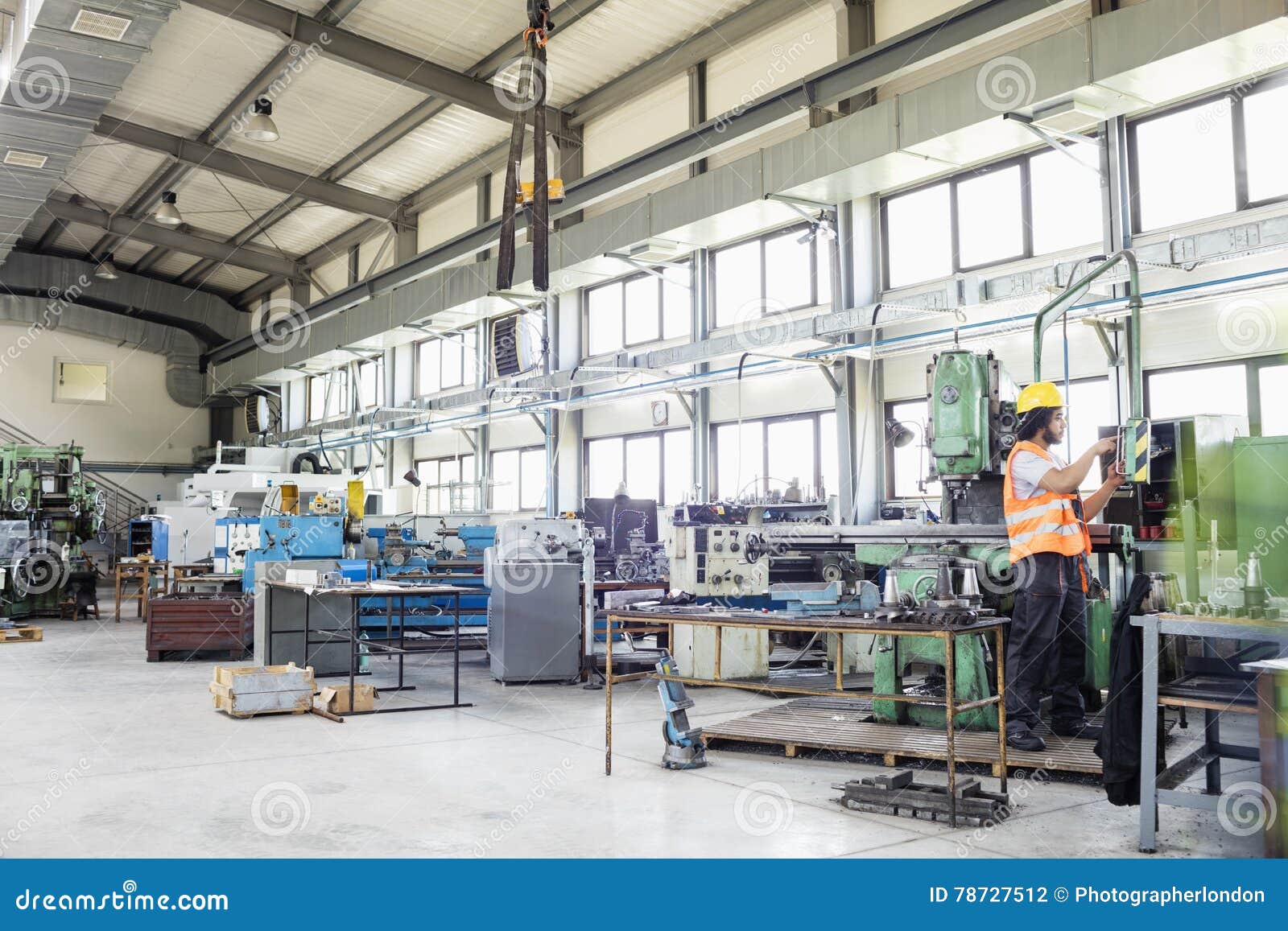 Young Manual Worker Operating Machinery in Metal Industry Stock Photo ...