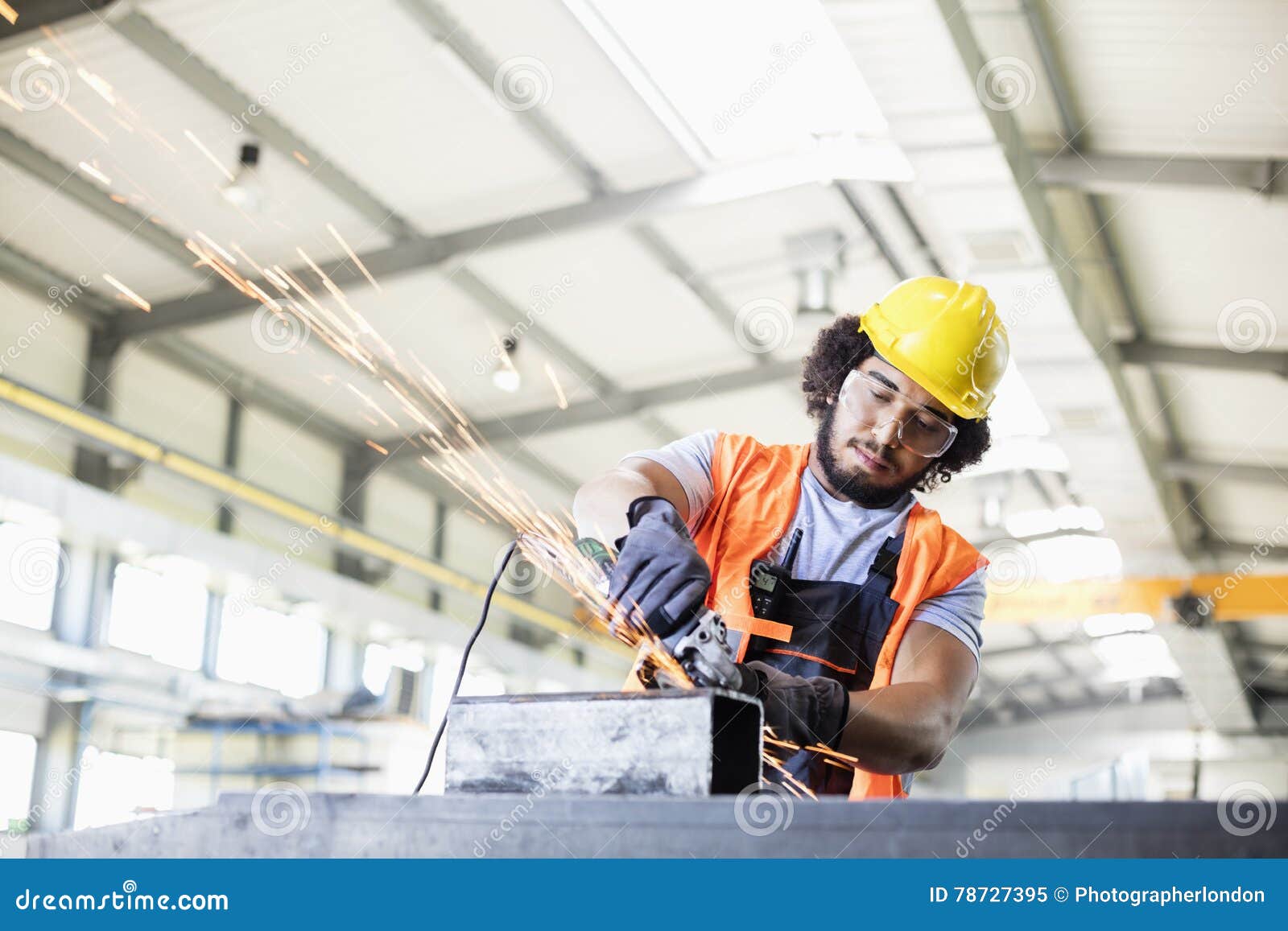 Young Manual Worker Using Grinder on Metal in Factory Stock Image ...