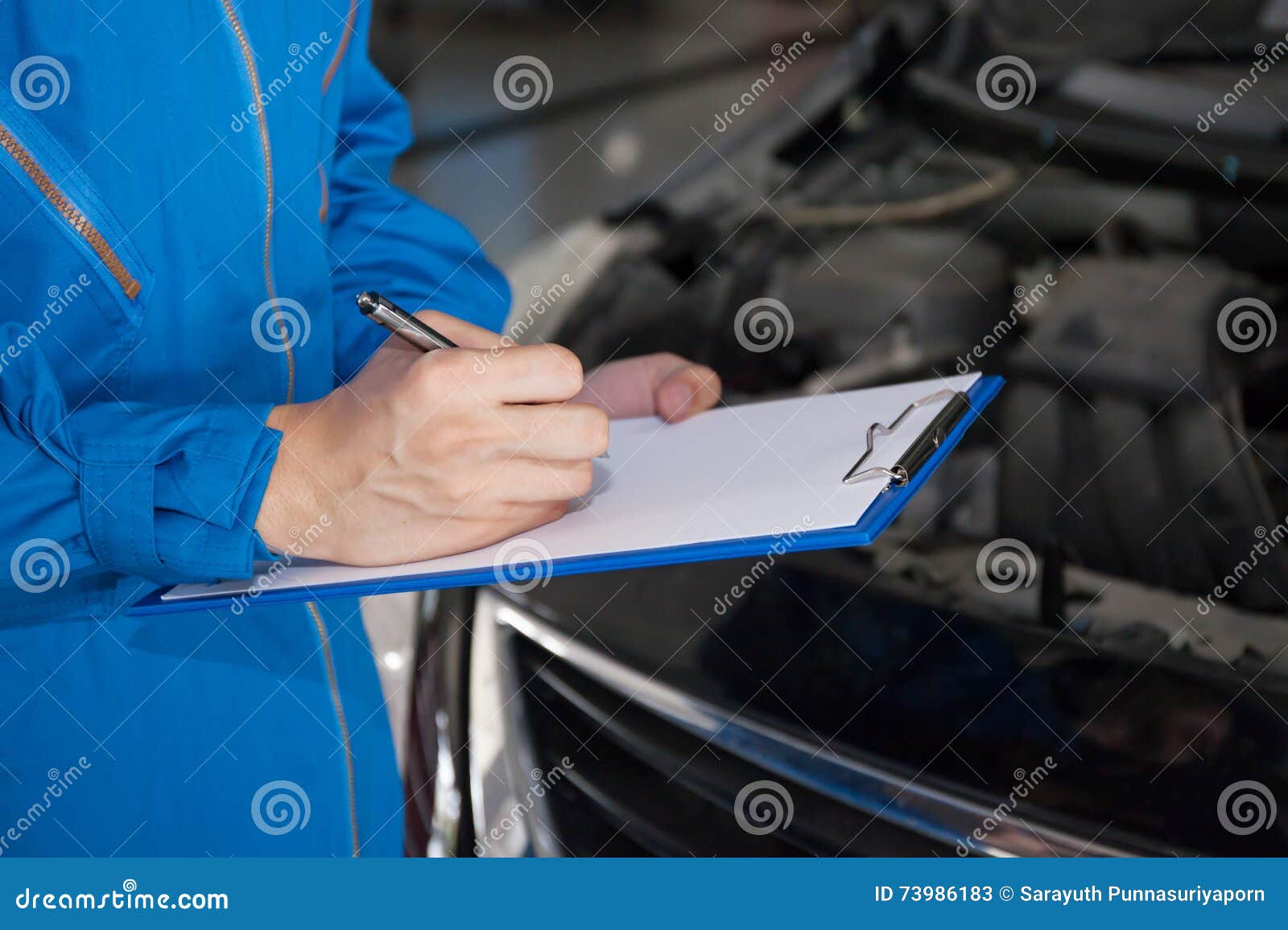 Young Mechanic Engineer Taking a Note on Clipboard for Examining Stock ...