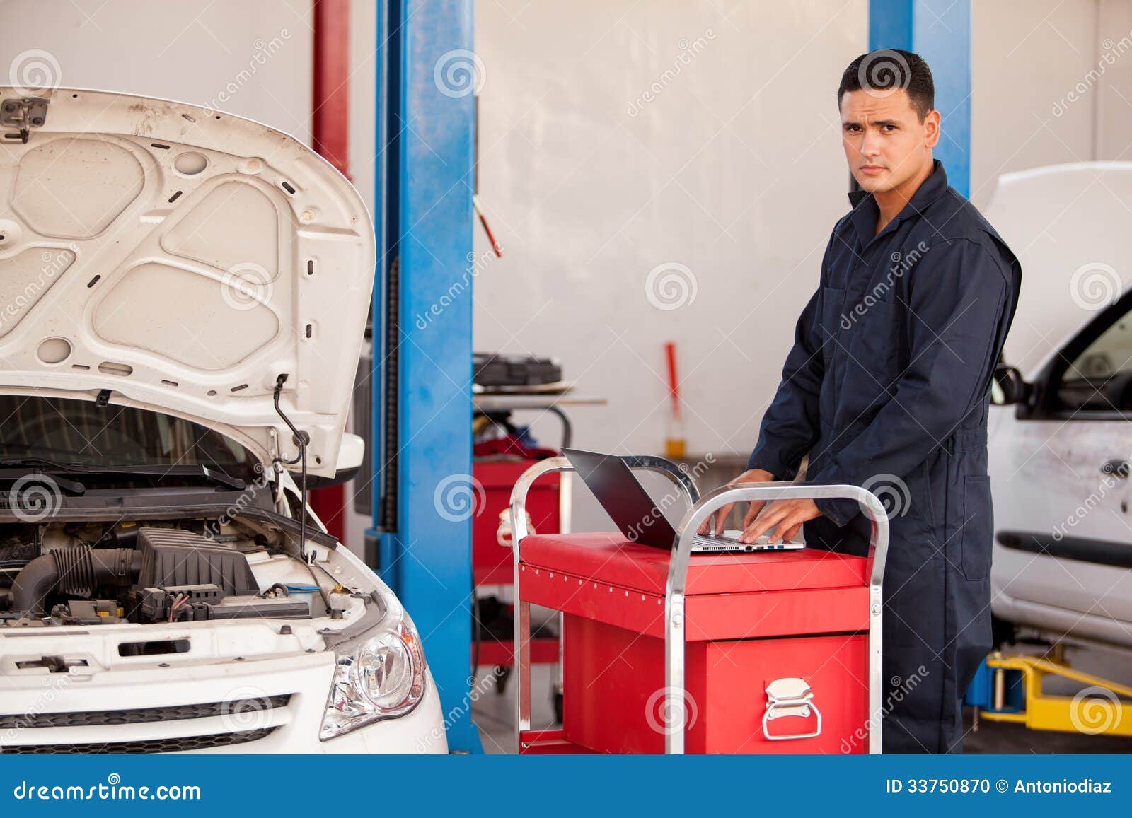 Young Mechanic Using a Computer Stock Photo - Image of mechanic, hood ...