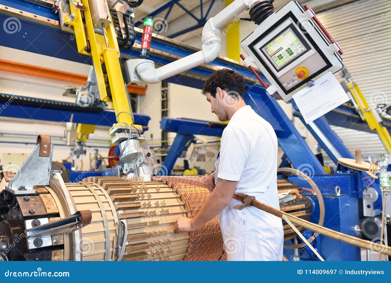 Young Mechanical Engineering Workers Operate a Machine for Winding ...
