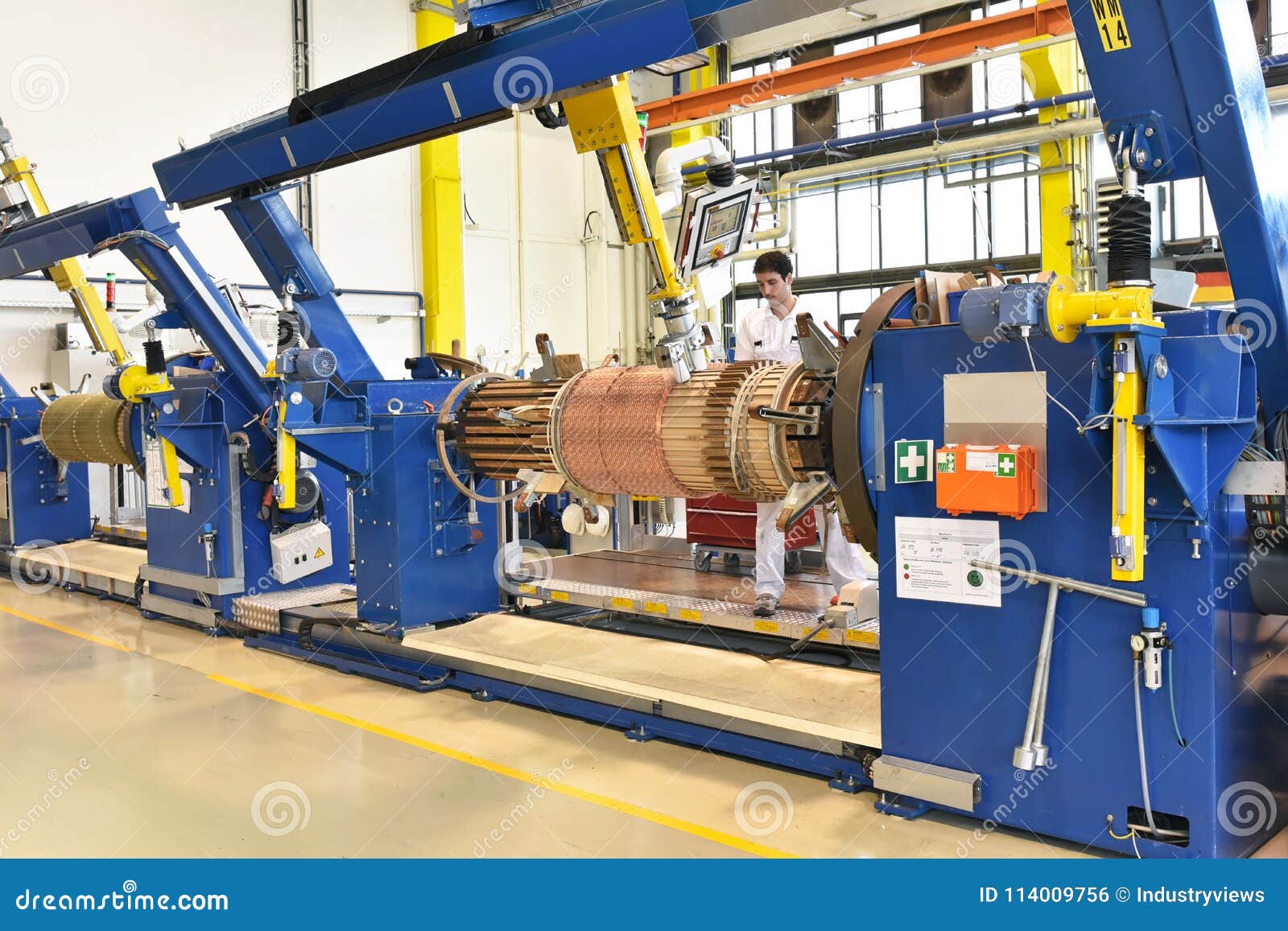 Young Mechanical Engineering Workers Operate a Machine for Winding ...