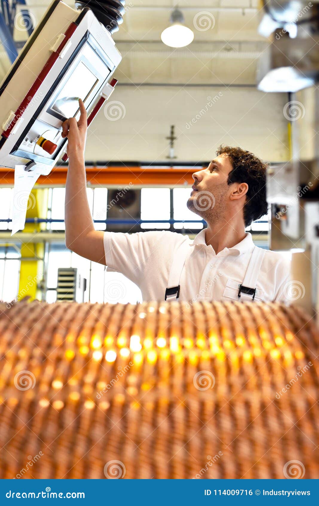 Young Mechanical Engineering Workers Operate a Machine for Winding ...