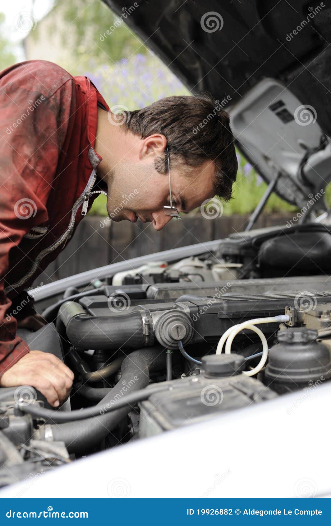 Young Mechanist Checking a Car Engine Stock Photo - Image of outdoors ...