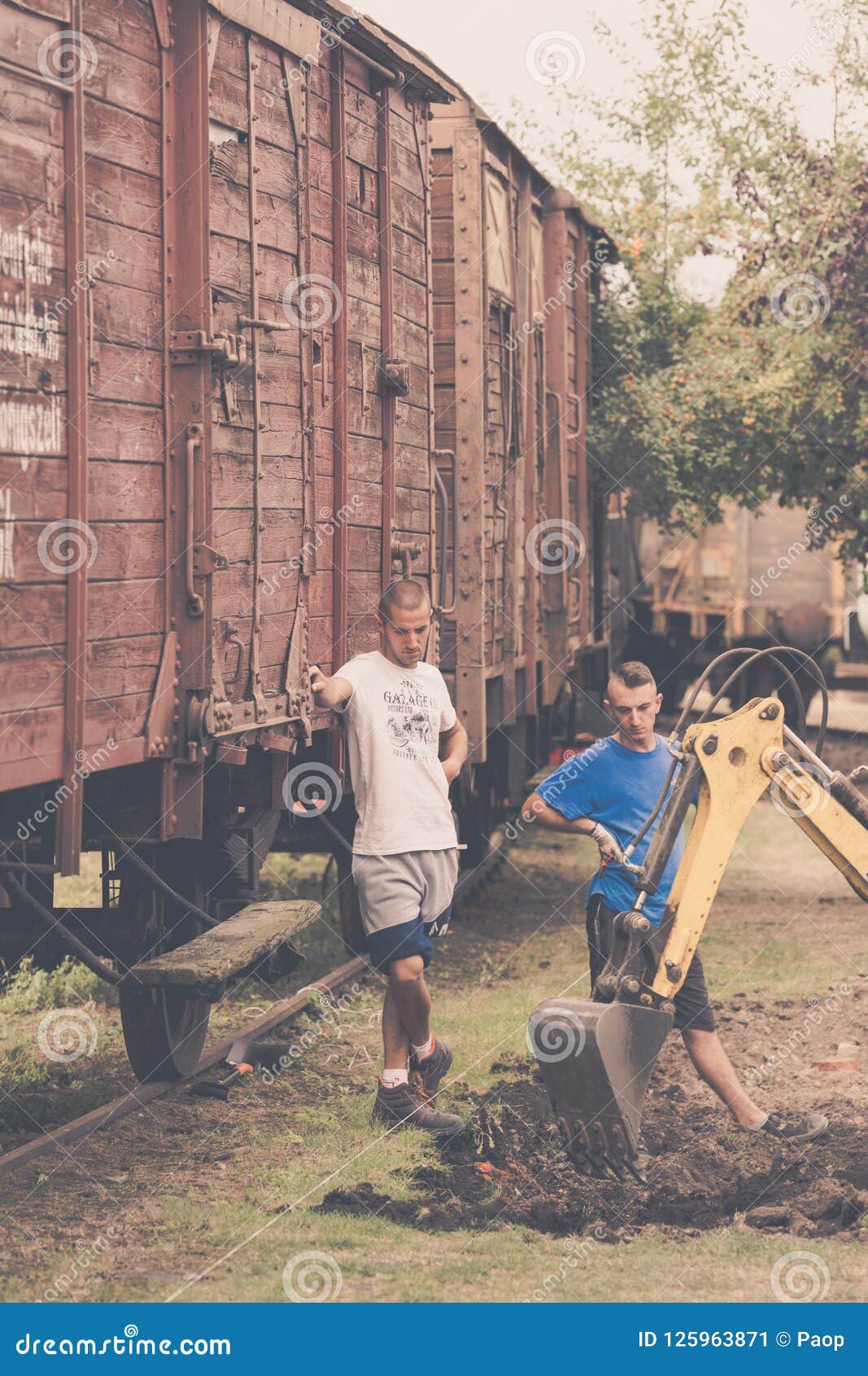 Young Men and Digger at Work Editorial Photo - Image of construction ...