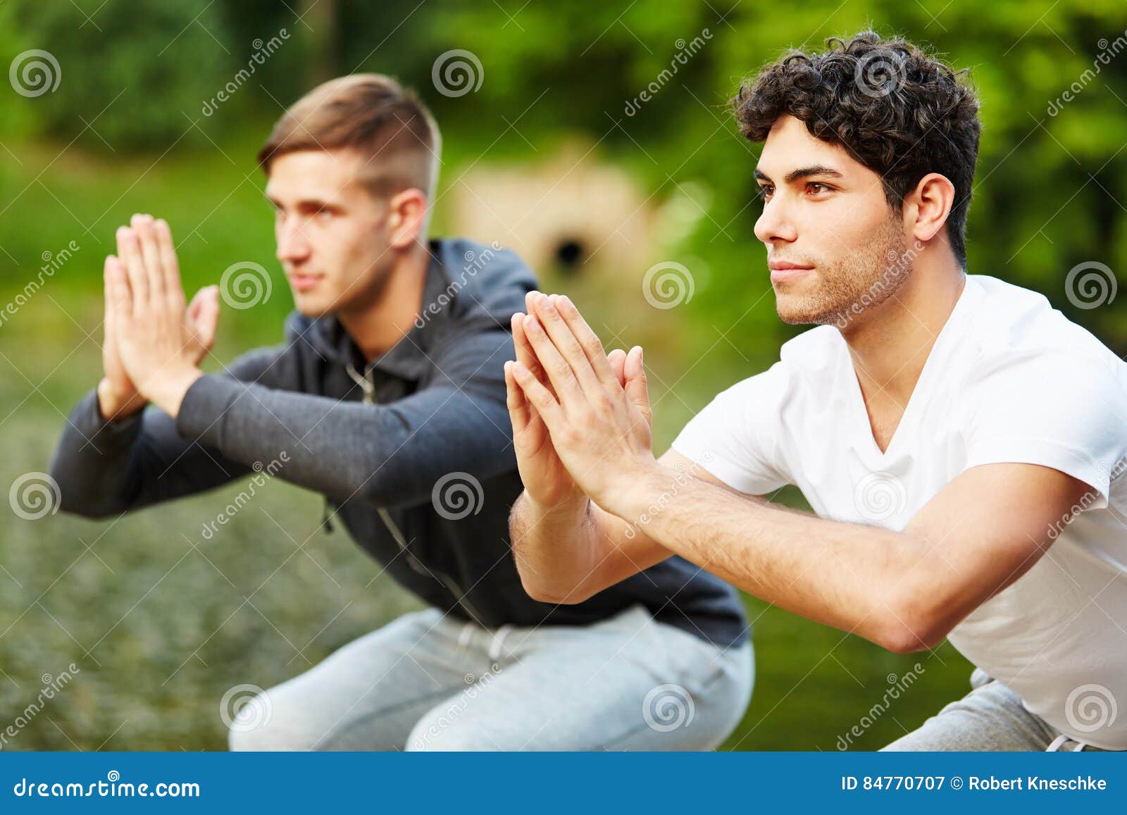 Young men doing squats stock image. Image of nature, training - 84770707