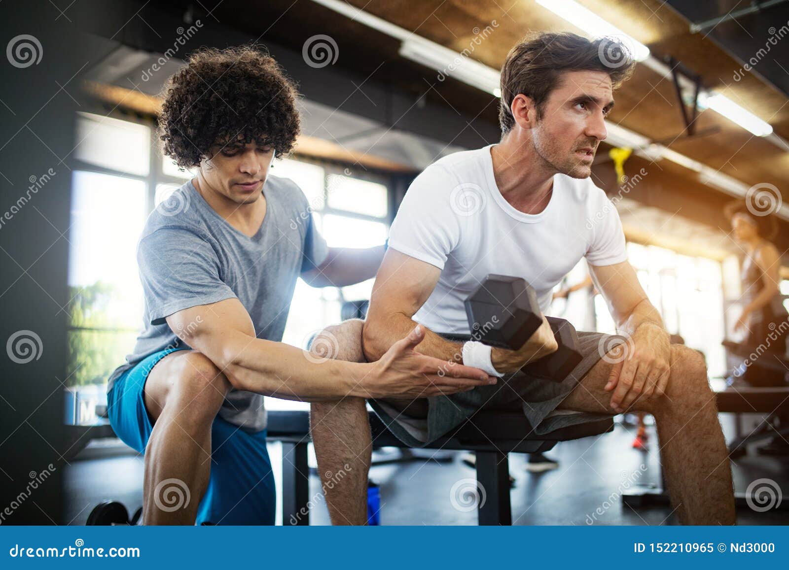 Young Fit Man Doing Workout with a Personal Trainer. Stock Image ...