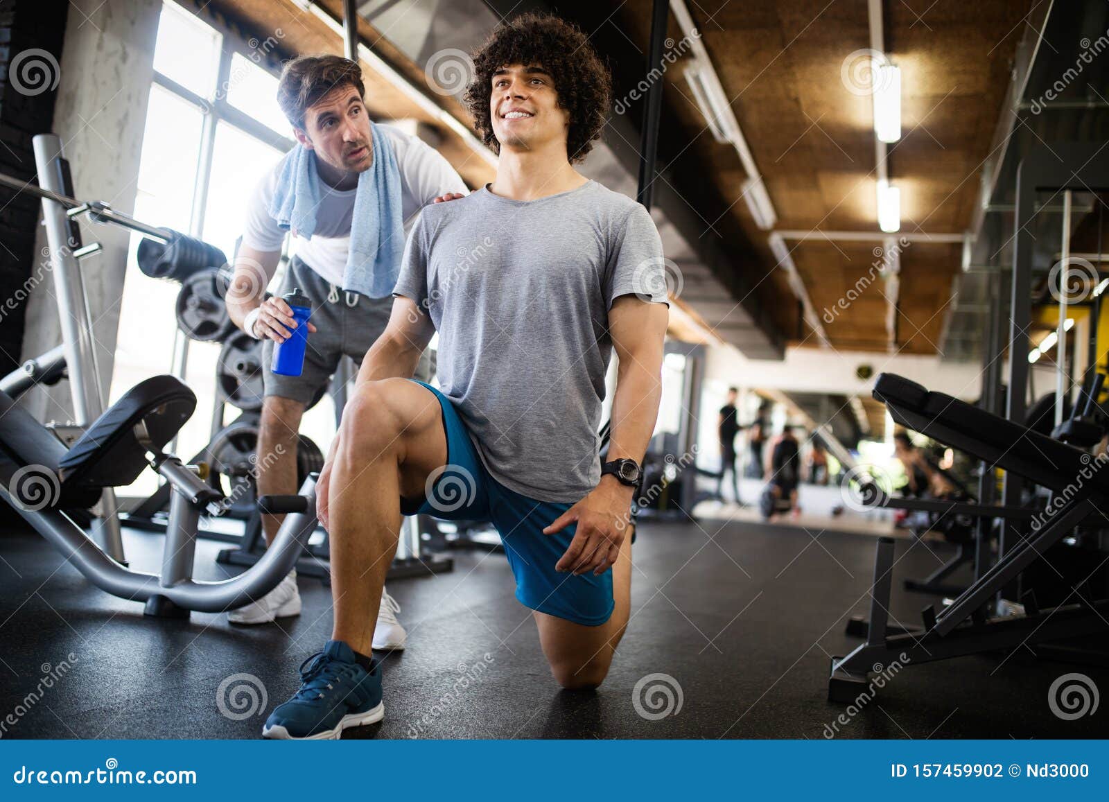 Young Fit Man Doing Workout with a Personal Trainer. Stock Photo ...