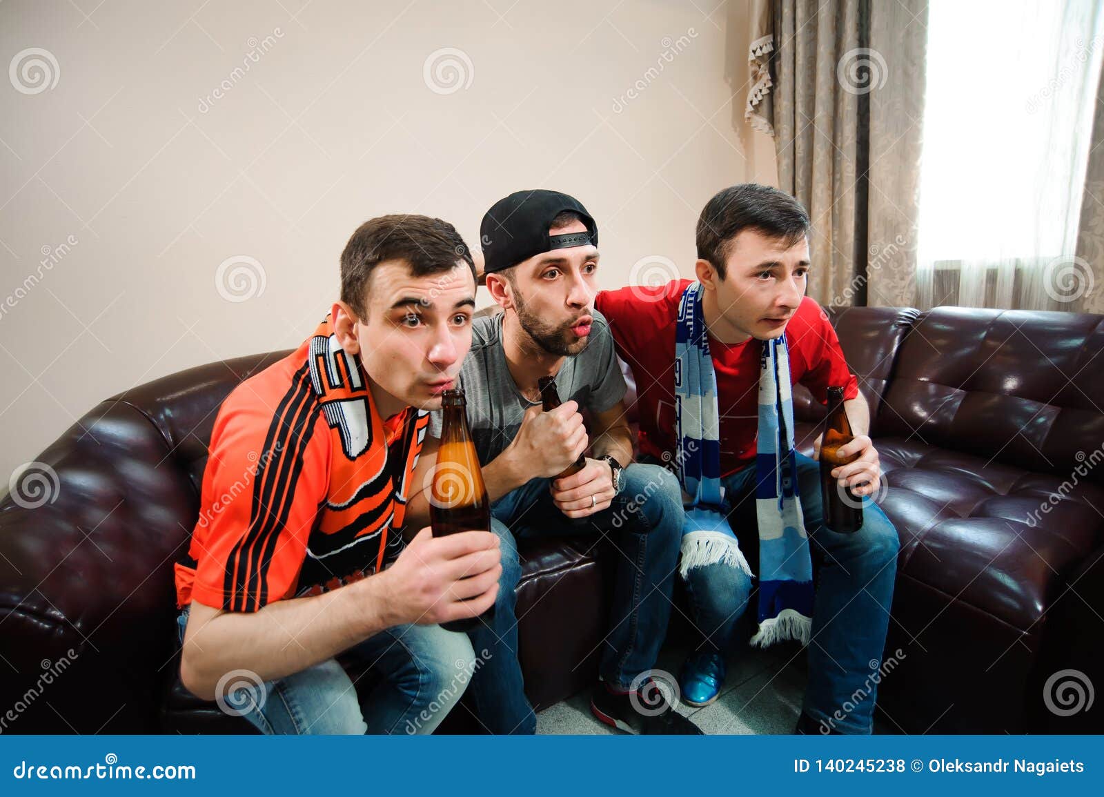 Young Men Drink Beer, Eat Chips and Root for Football. Stock Photo ...