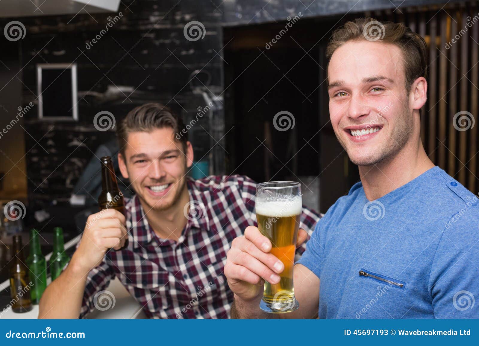 Young Men Drinking Beer Together Stock Image - Image of looking, people ...