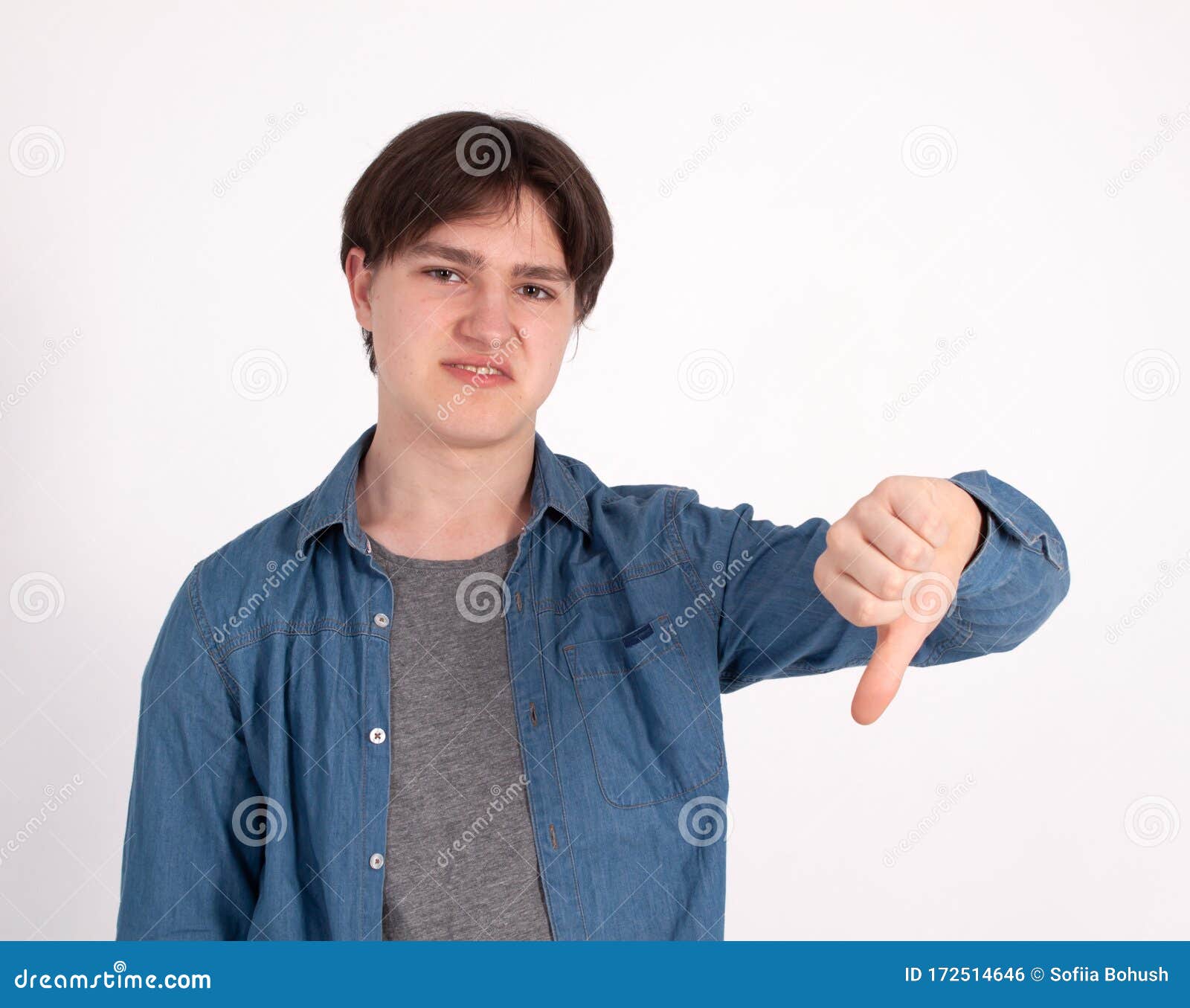 Young Men Expressing Disgust and Showing Thumb Down Sign Stock Photo ...