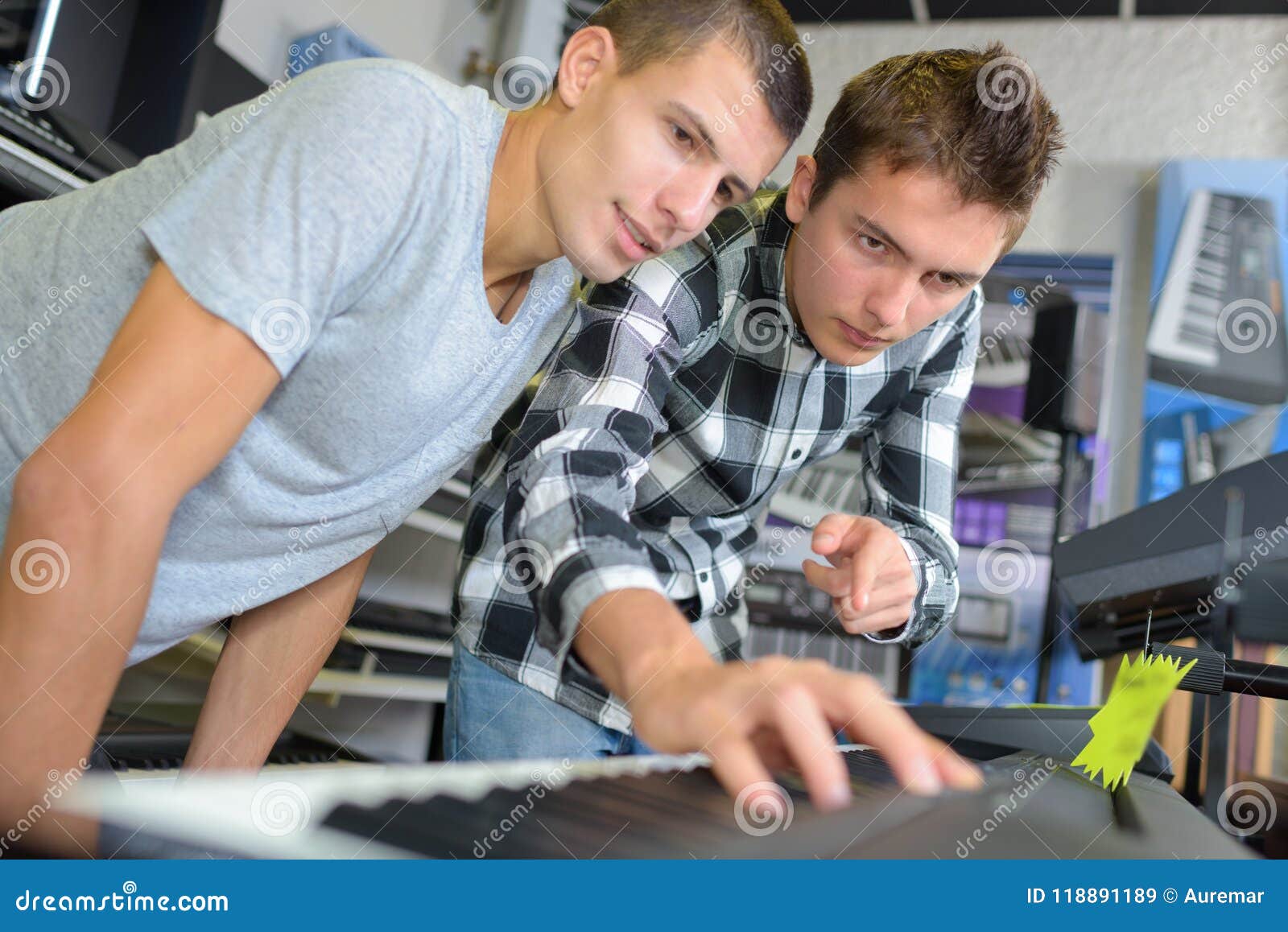 Young Men Looking at Electronic Keyboard Stock Image - Image of play ...
