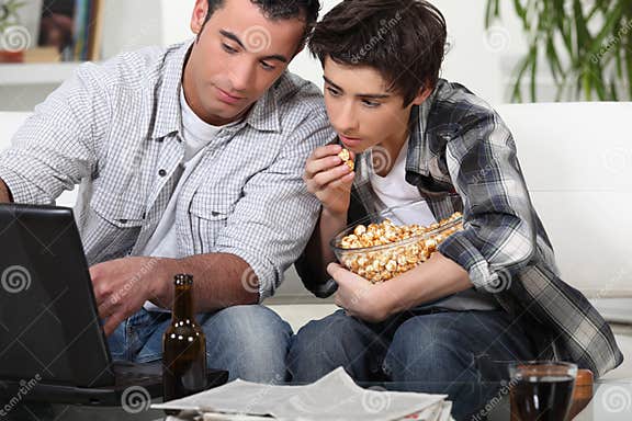 Young Men Looking at Laptop Stock Image - Image of adolescent, living ...