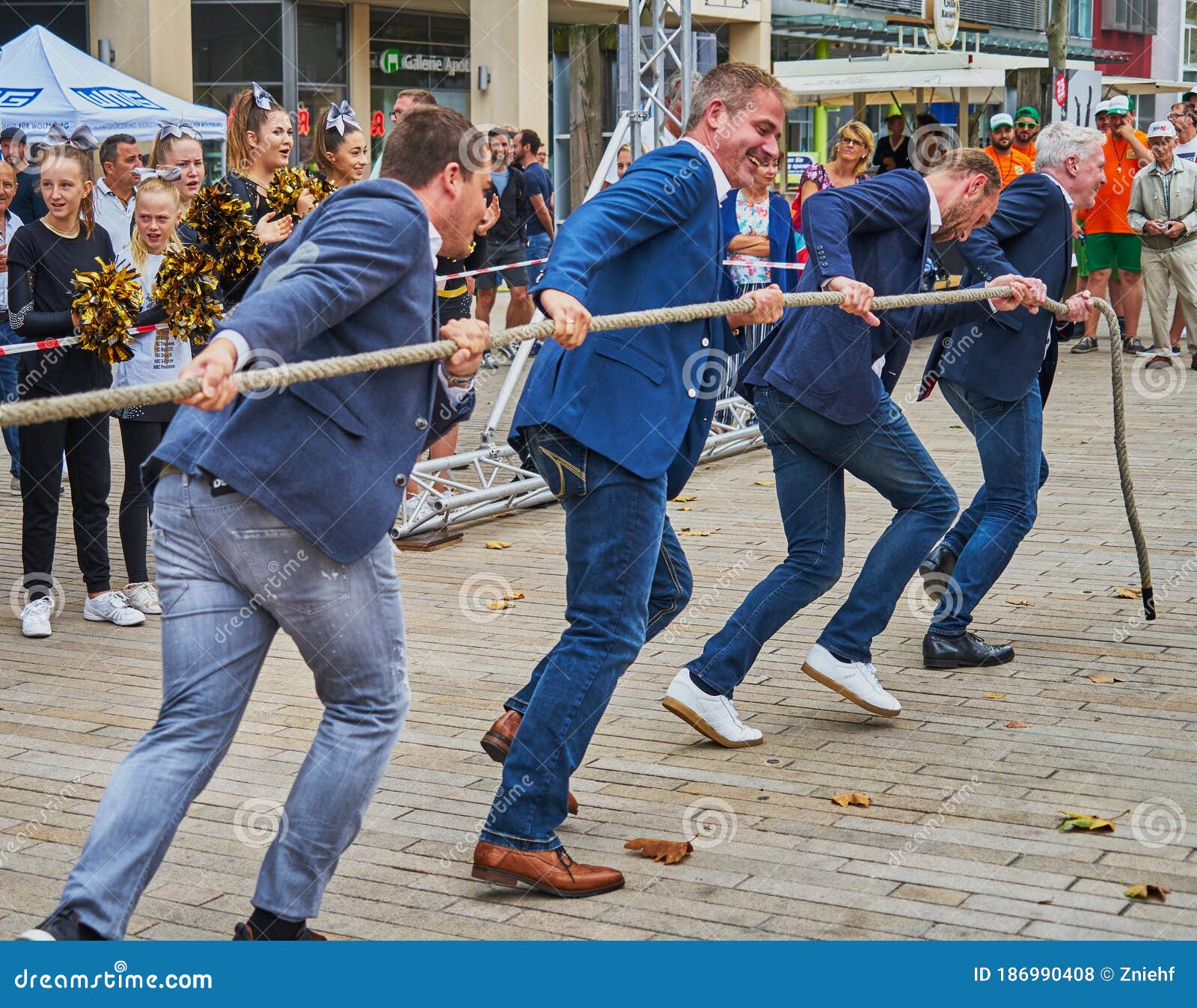 Young Men and Middle-aged Men Pull Together on a Rope during the Fun ...