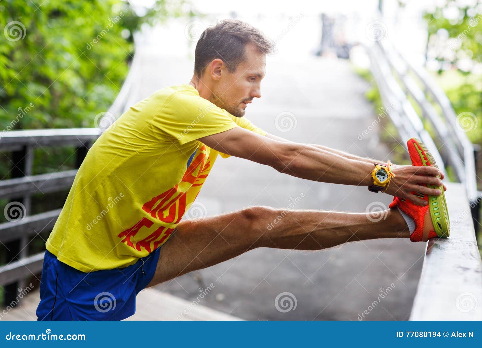 Young Men Performs Stretching before Jogging Stock Photo - Image of ...