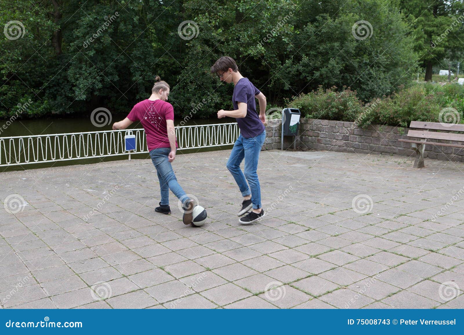 Young Men Playing with a Ball Stock Image - Image of kick, people: 75008743