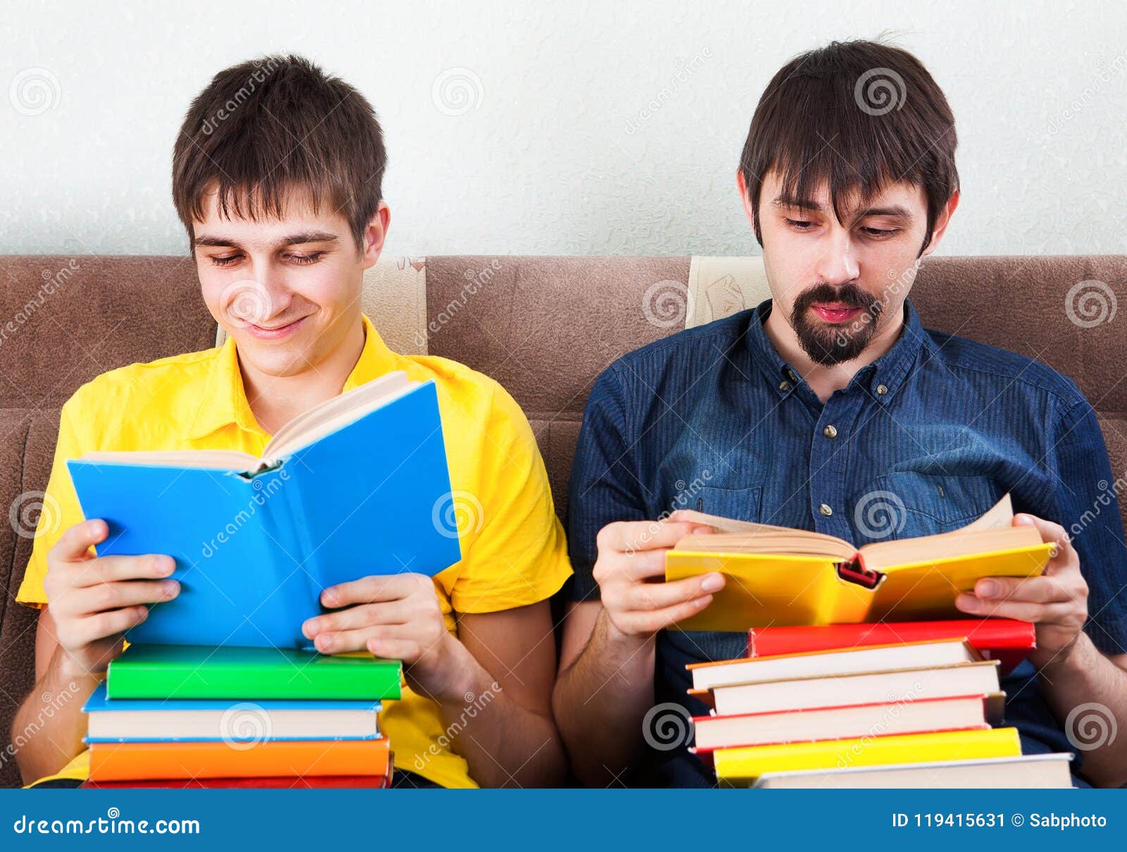 Young Men read a Books stock image. Image of couch, books - 119415631