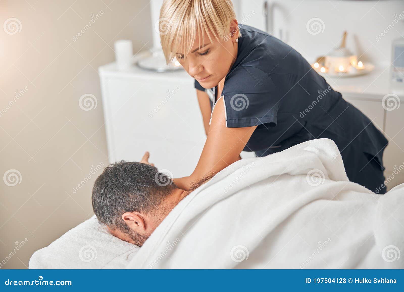 Professional Masseur Massaging Male Client Back In Spa Salon Stock